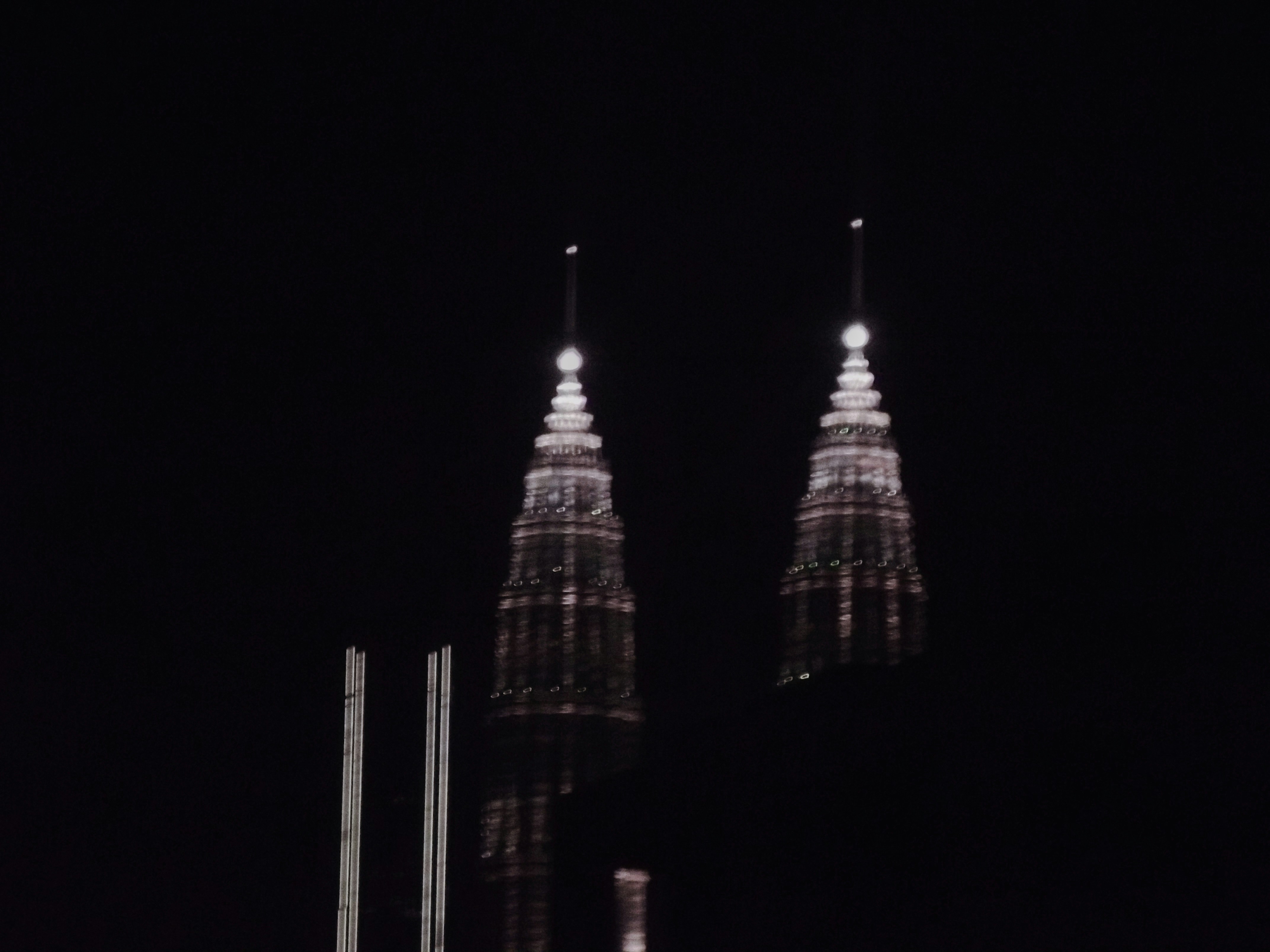 Midnight Lanterns: The Petronas Twin Towers Loom in Quiet Darkness