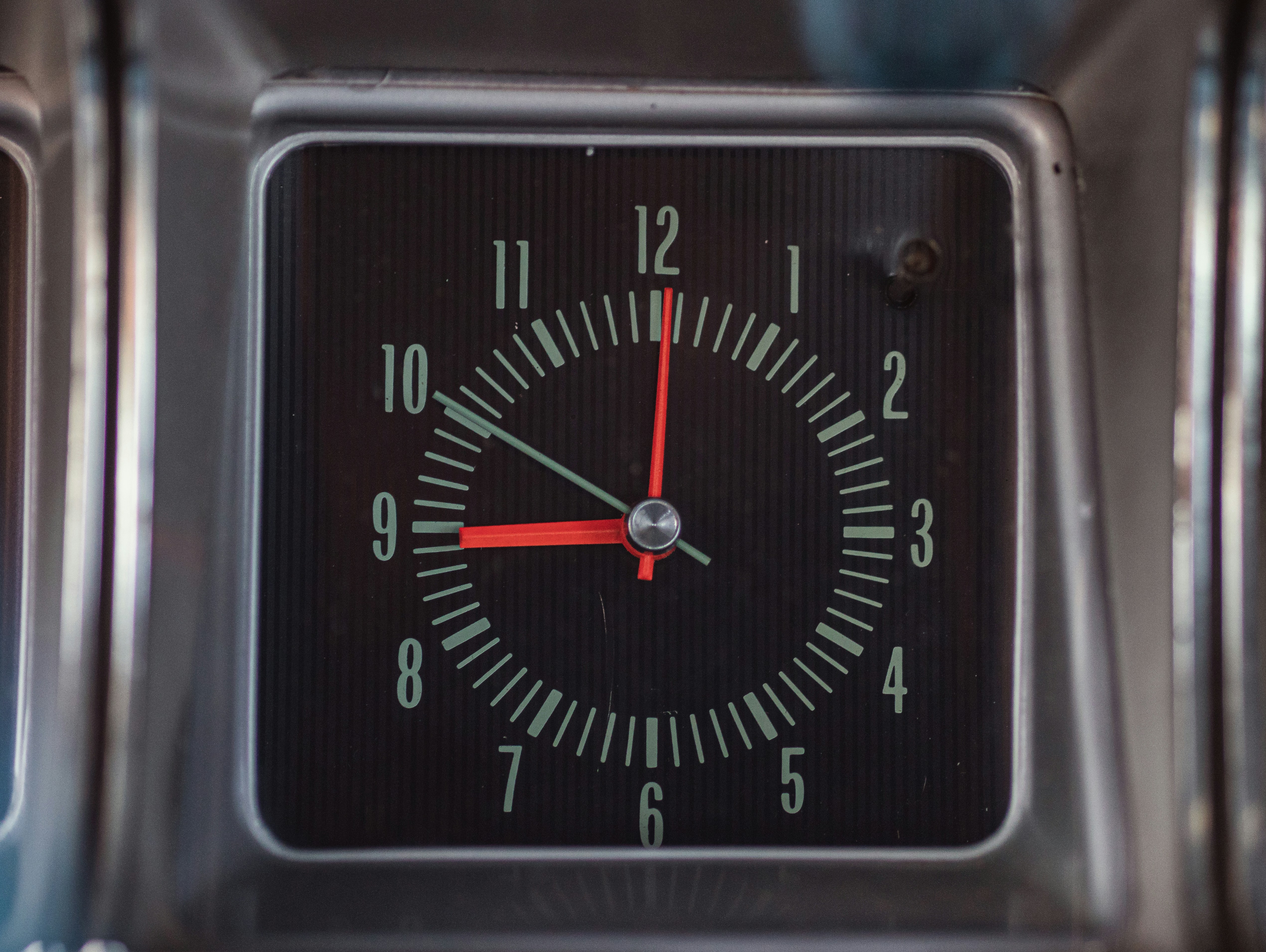 Chrome-Framed Clock Face: A Close-Up of Vintage Dashboard Time