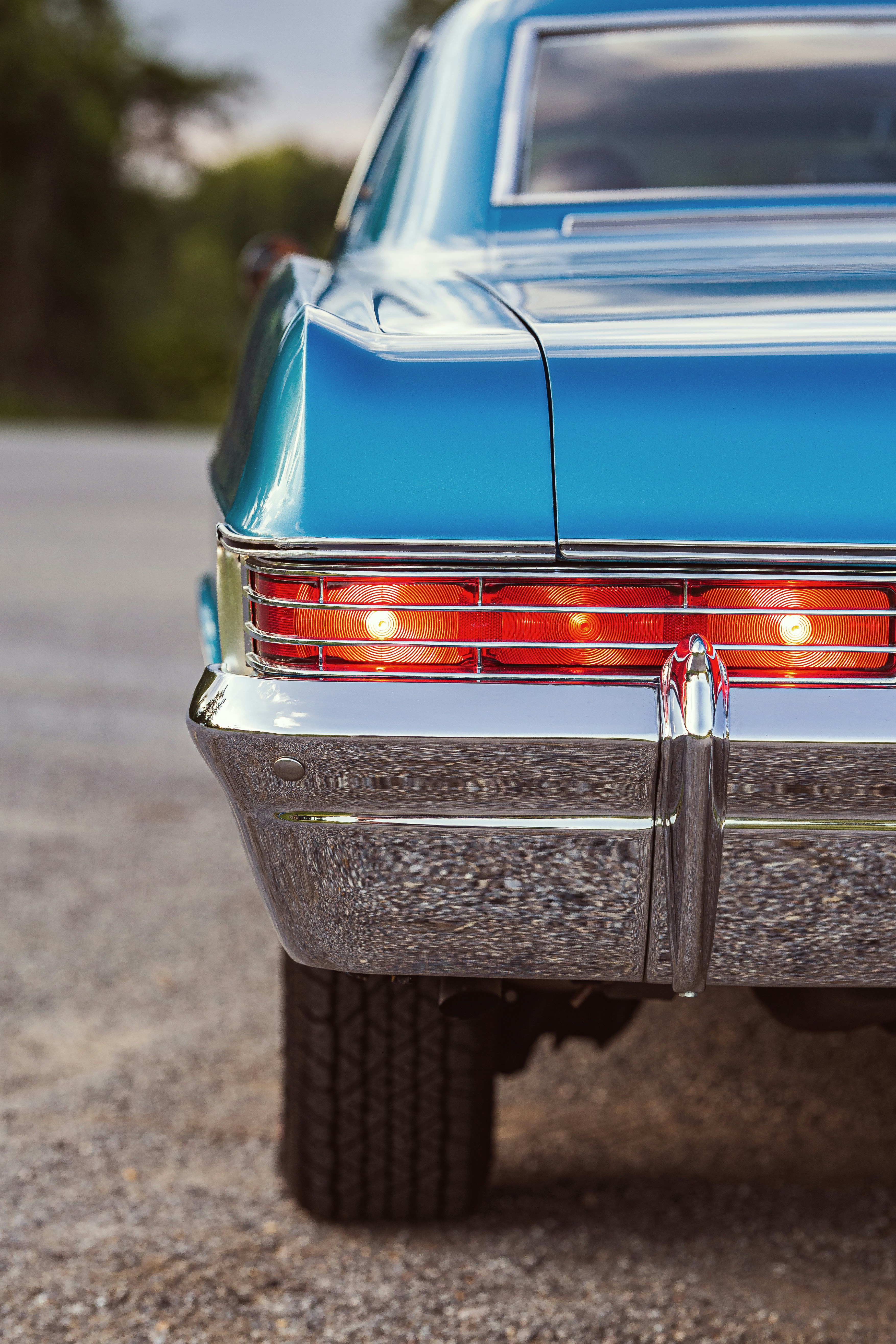 Blue Classic Tailfin: Chrome Glints and Red Tail Lights