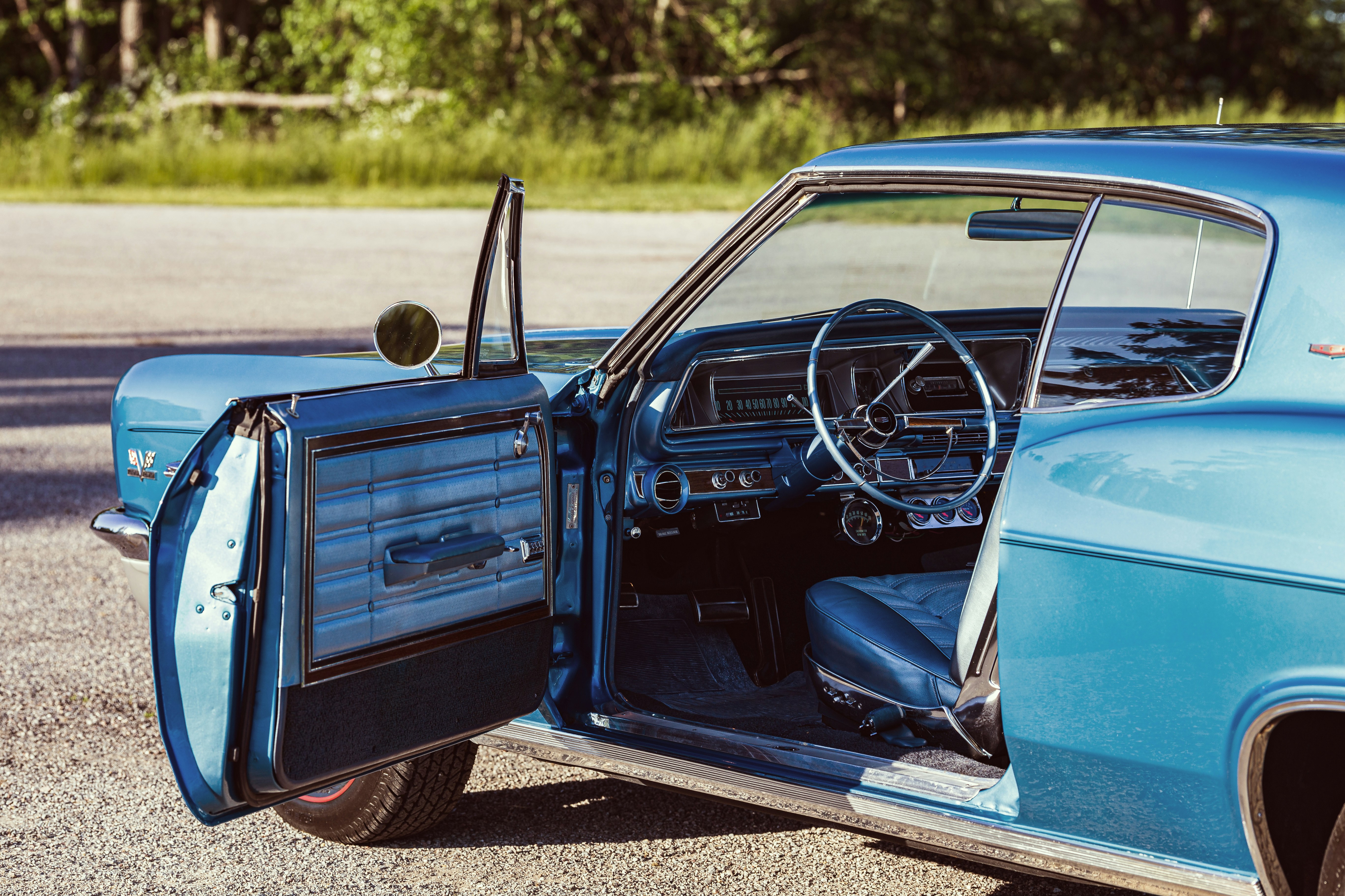 Sunlit Blue Classic: An Open-Door Portrait of a 1960s Chevrolet