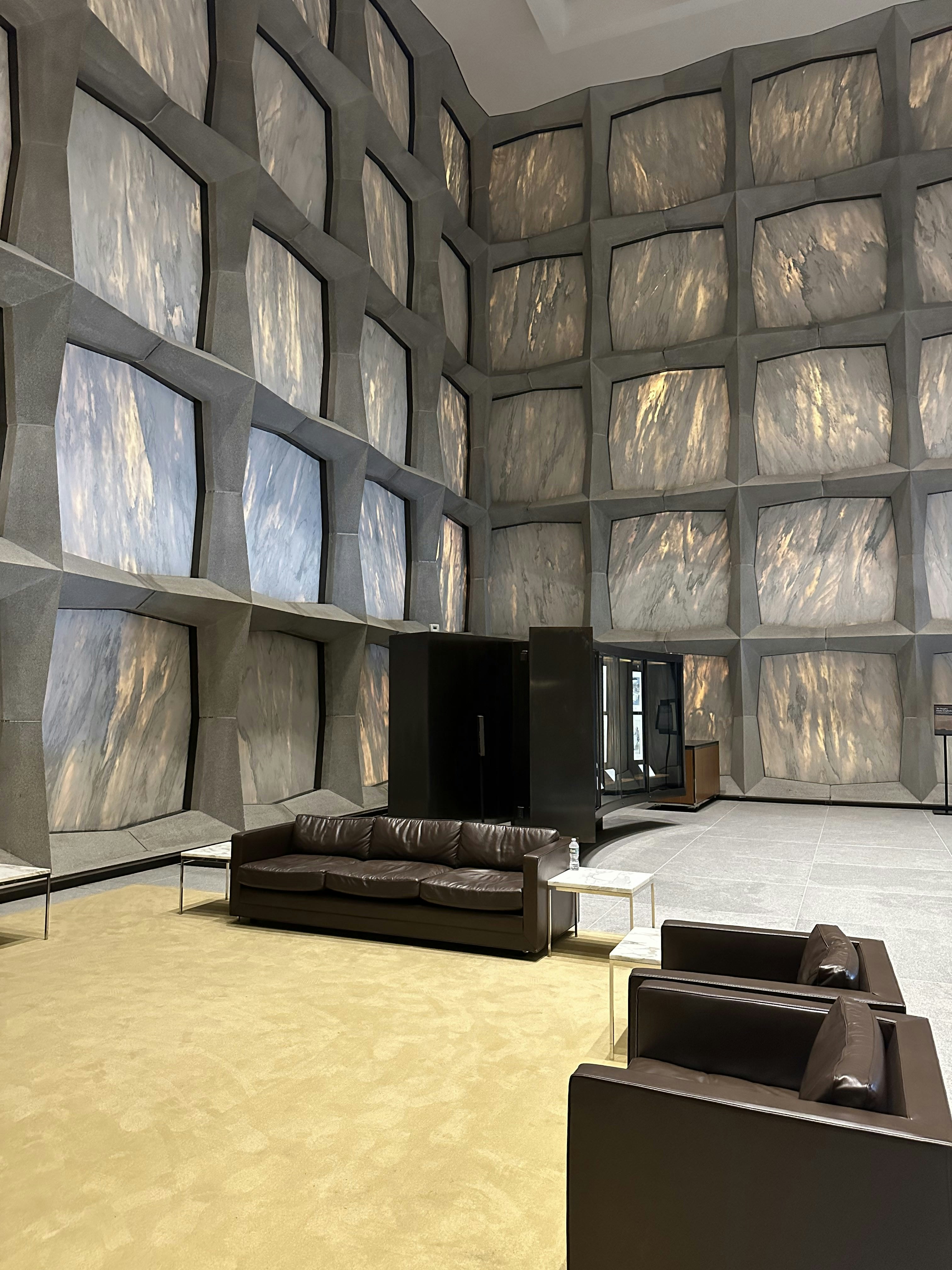 Geometric Vault: Leather Lounge in a Grid-Walled Atrium