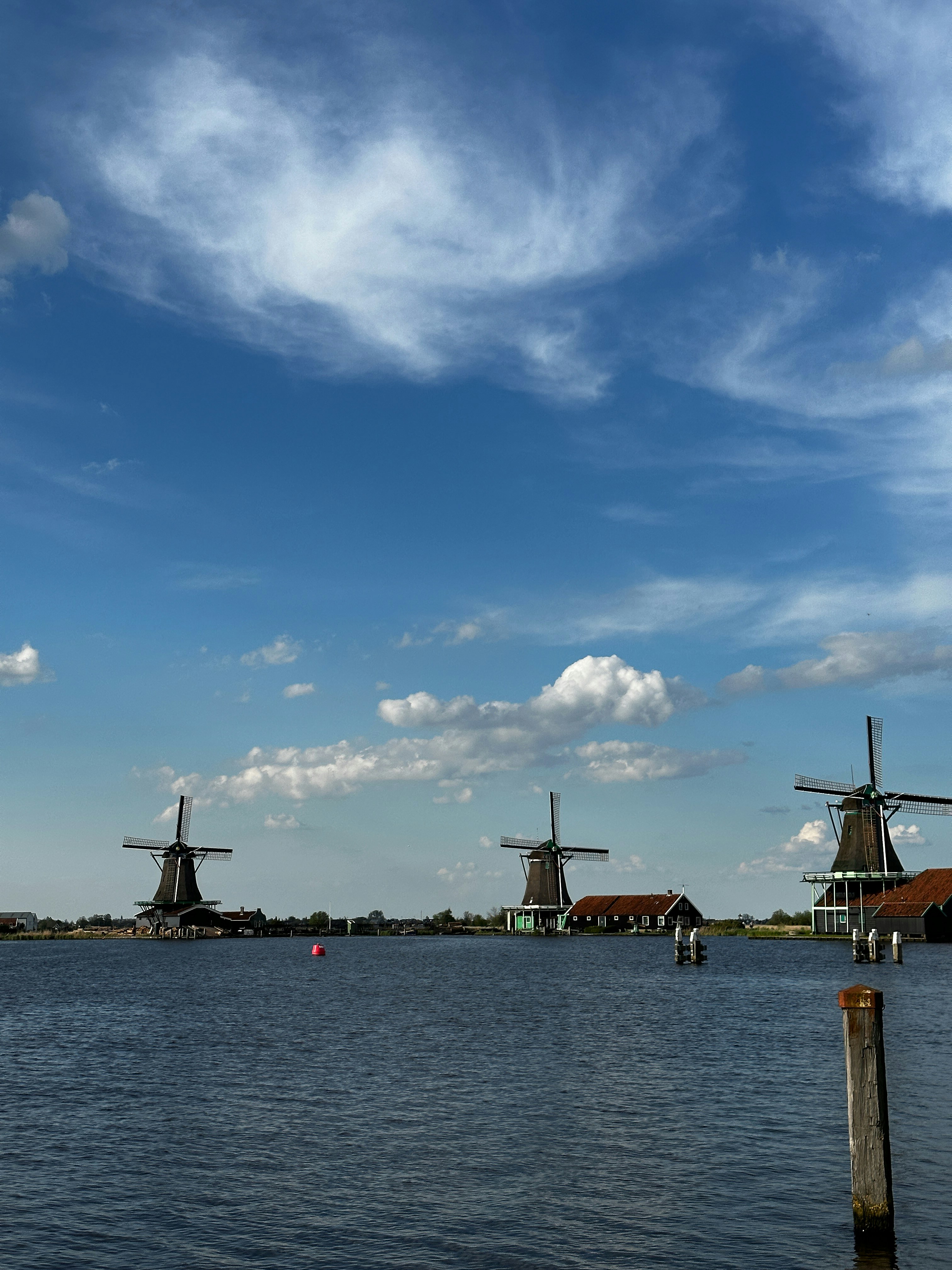 Three Windmills Framing a Quiet Dutch Waterway