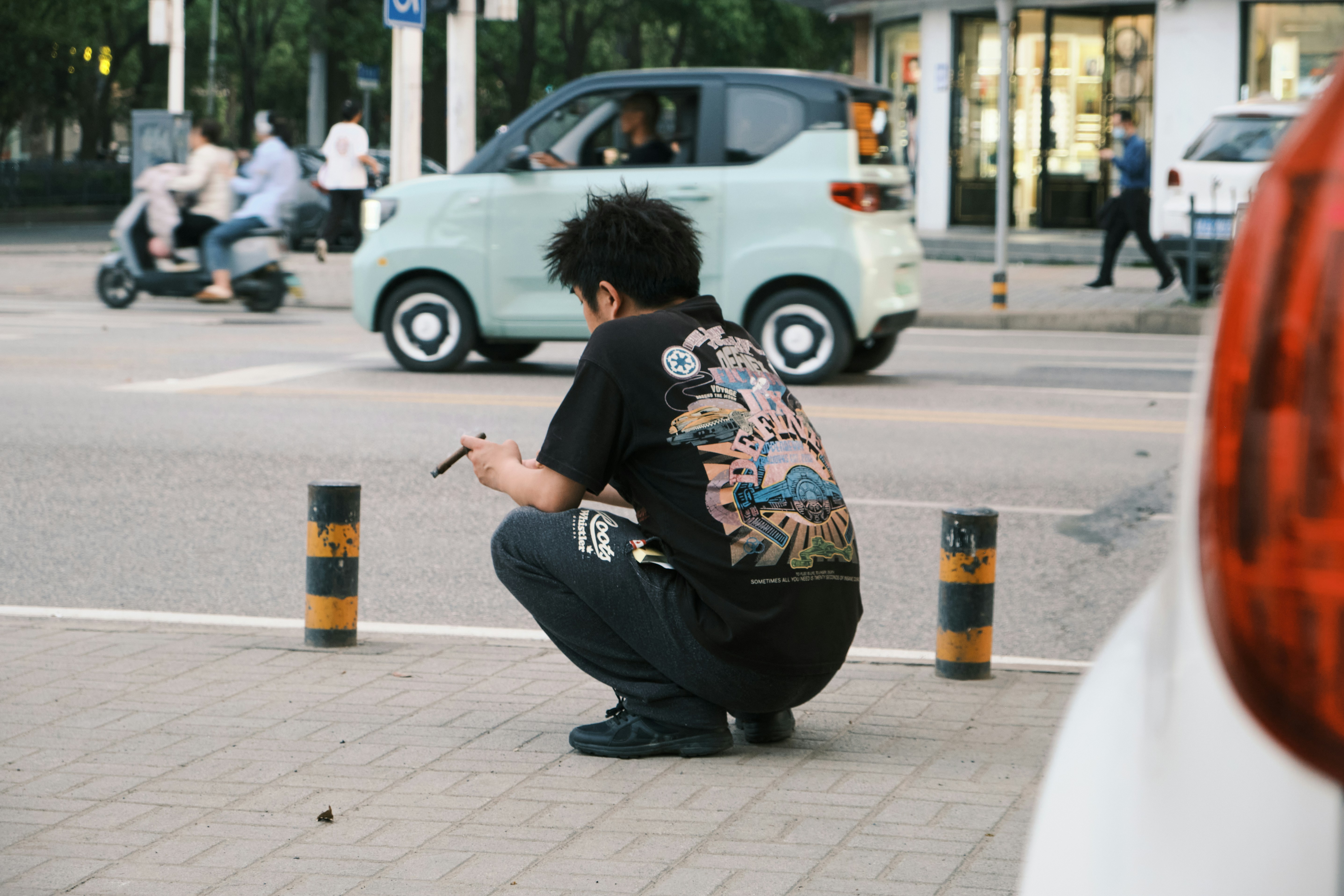 A man kneeling down on the side of a road photo – Free Hubei Image on ...
