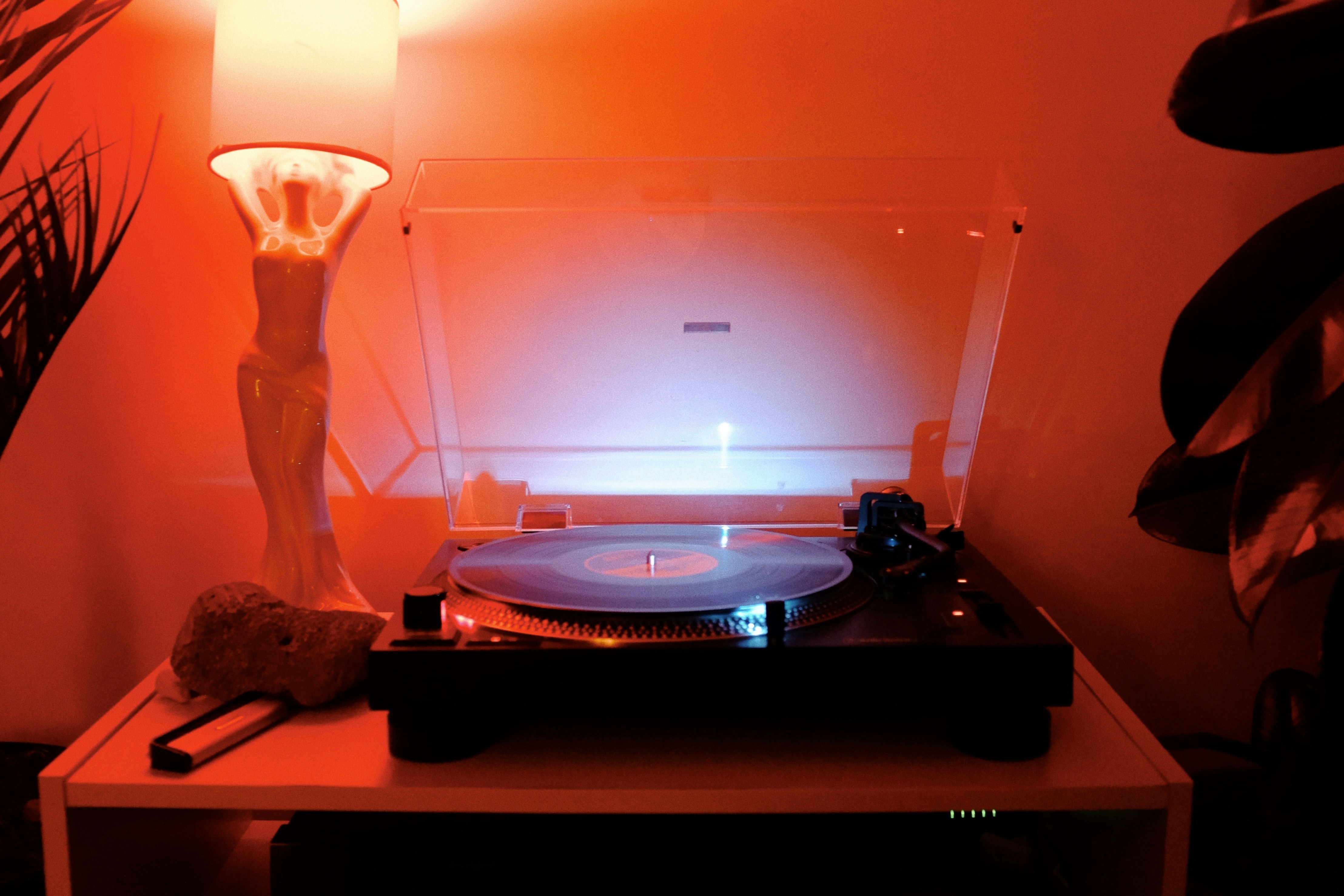 A turntable sitting on top of a table next to a lamp photo – Free Kyiv ...