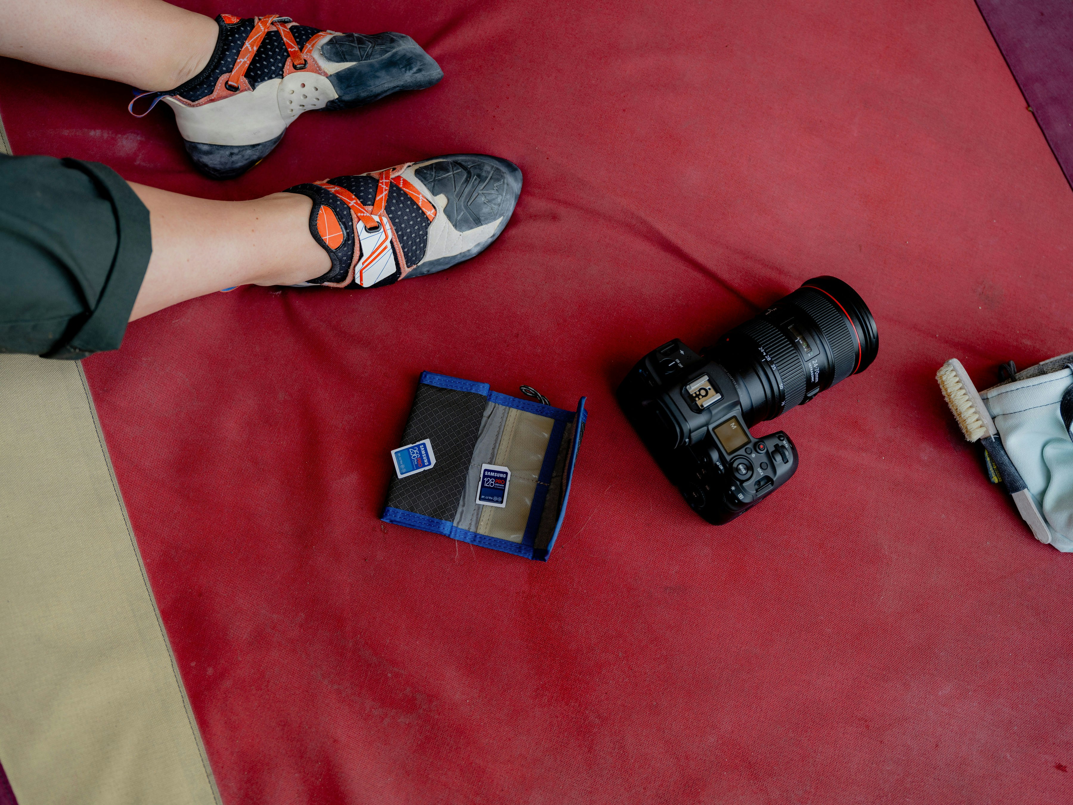 Crimson Studio Pause: Fujifilm GFX100S Resting Near Cards on a Red Mat