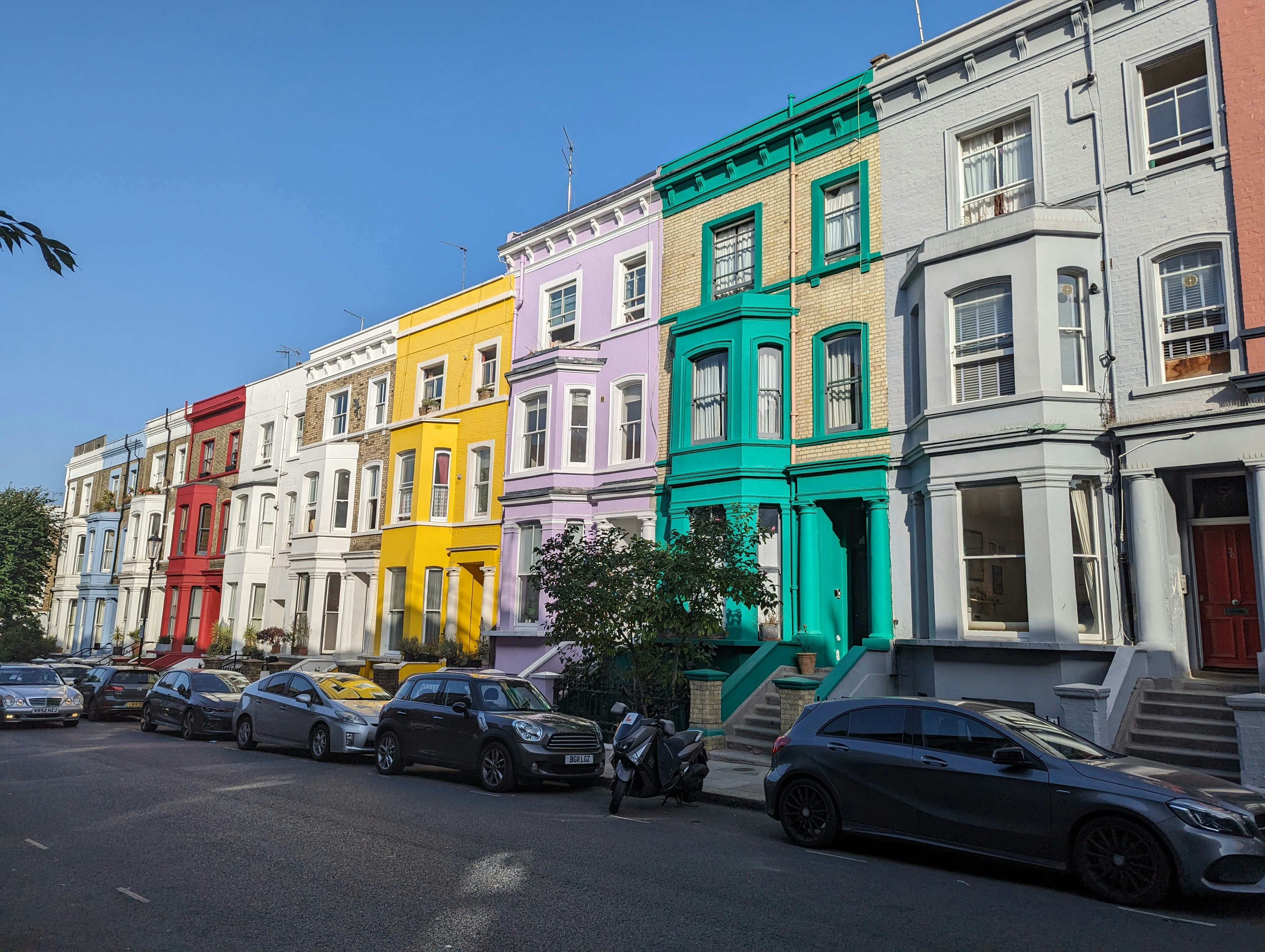 A row of multi - colored houses on a city street photo – Free London ...