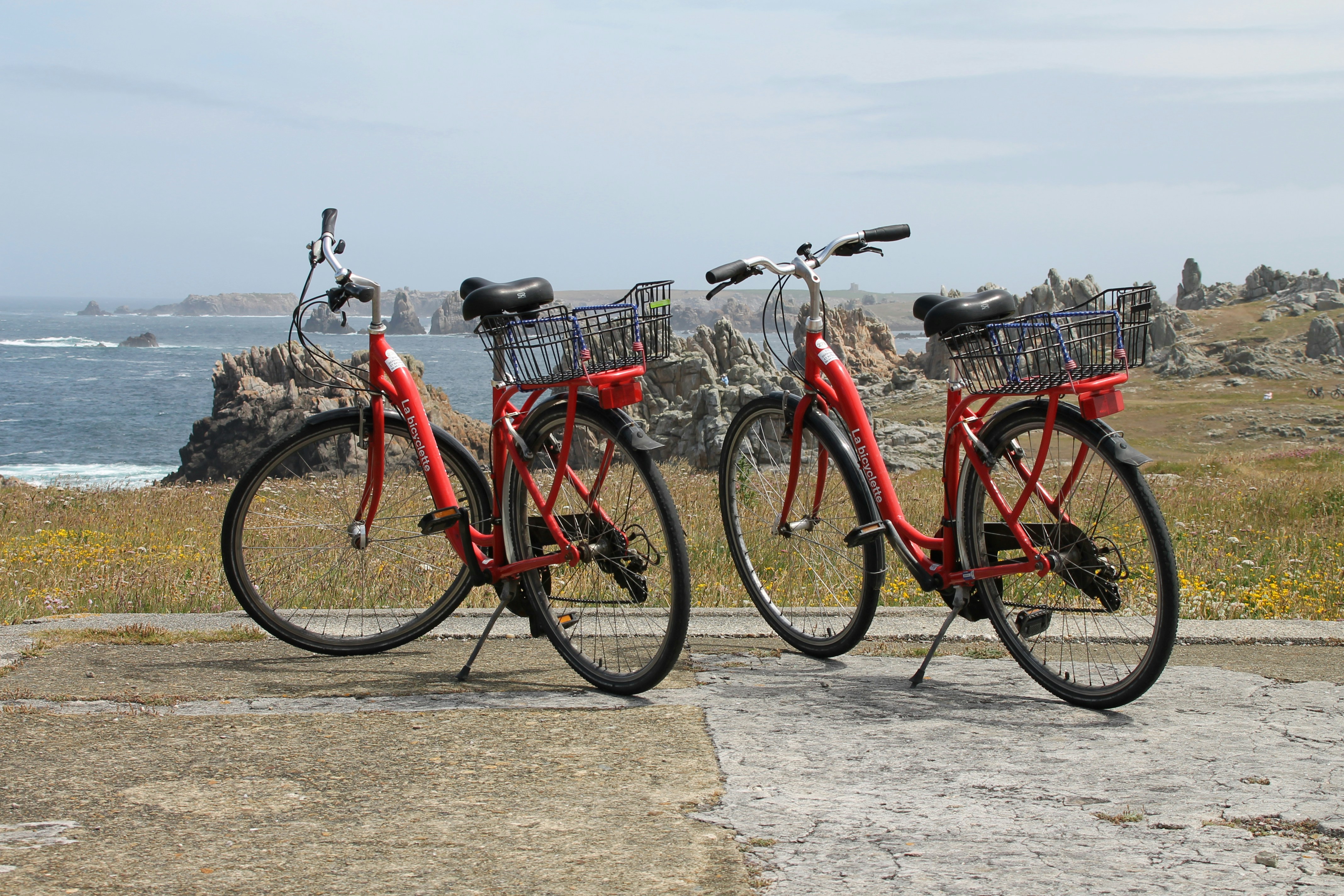 Two red bikes parked next to each other photo – Free Bicycle Image on ...
