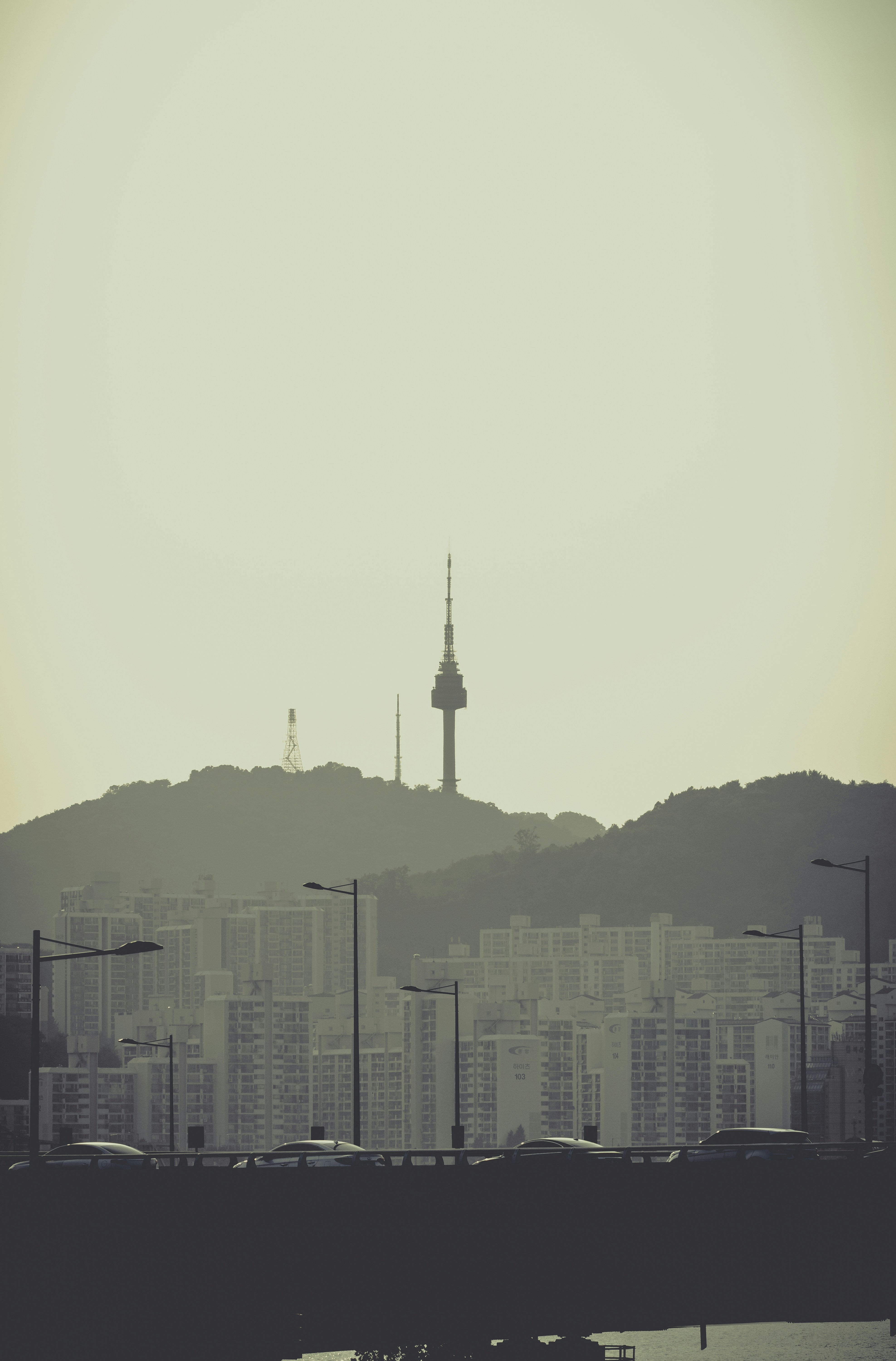 Spire on the Hilltop: A Pale Dawn Over a Layered City