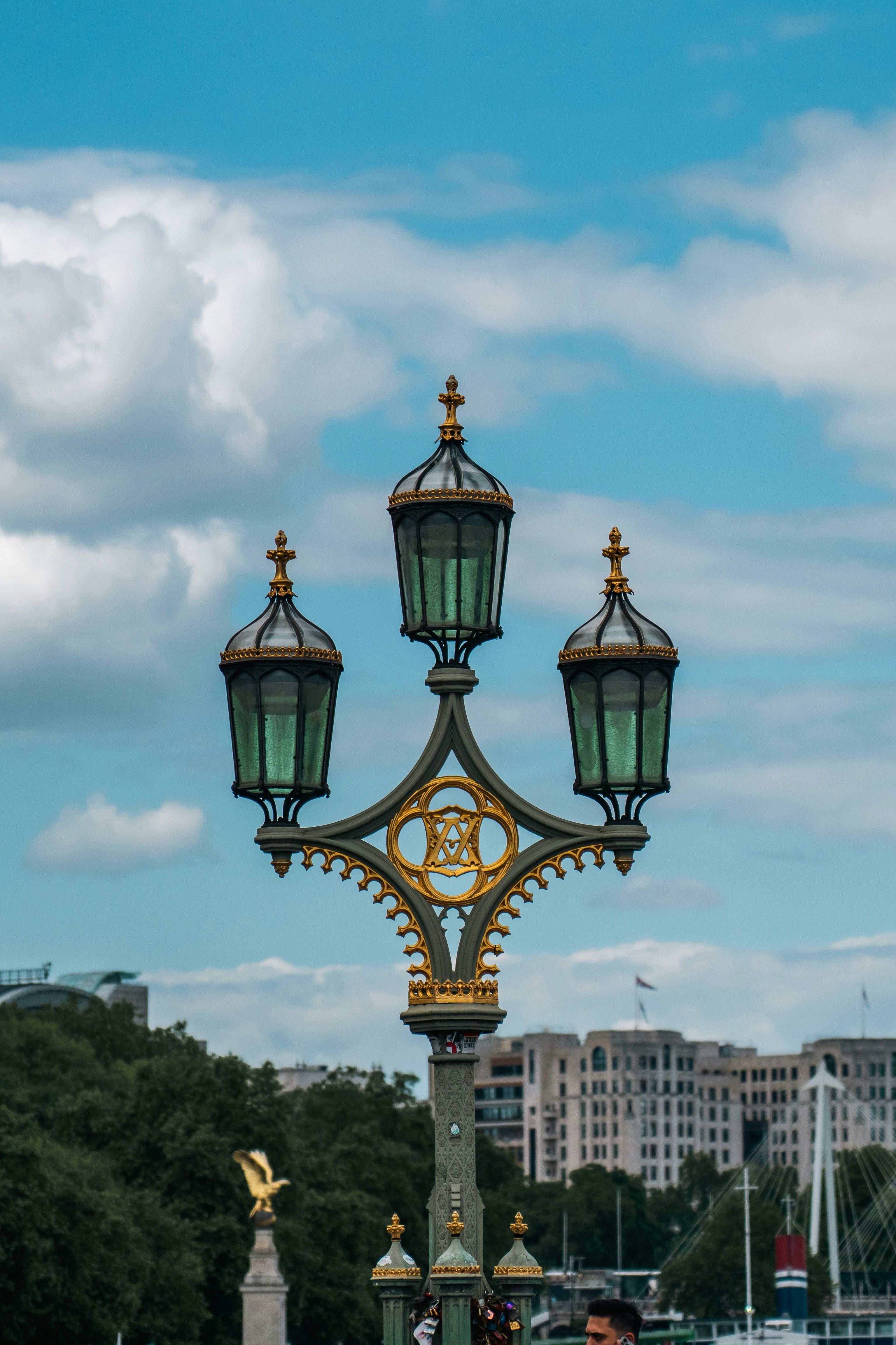 Gilded Lantern Trio Framing a Modern Harbor