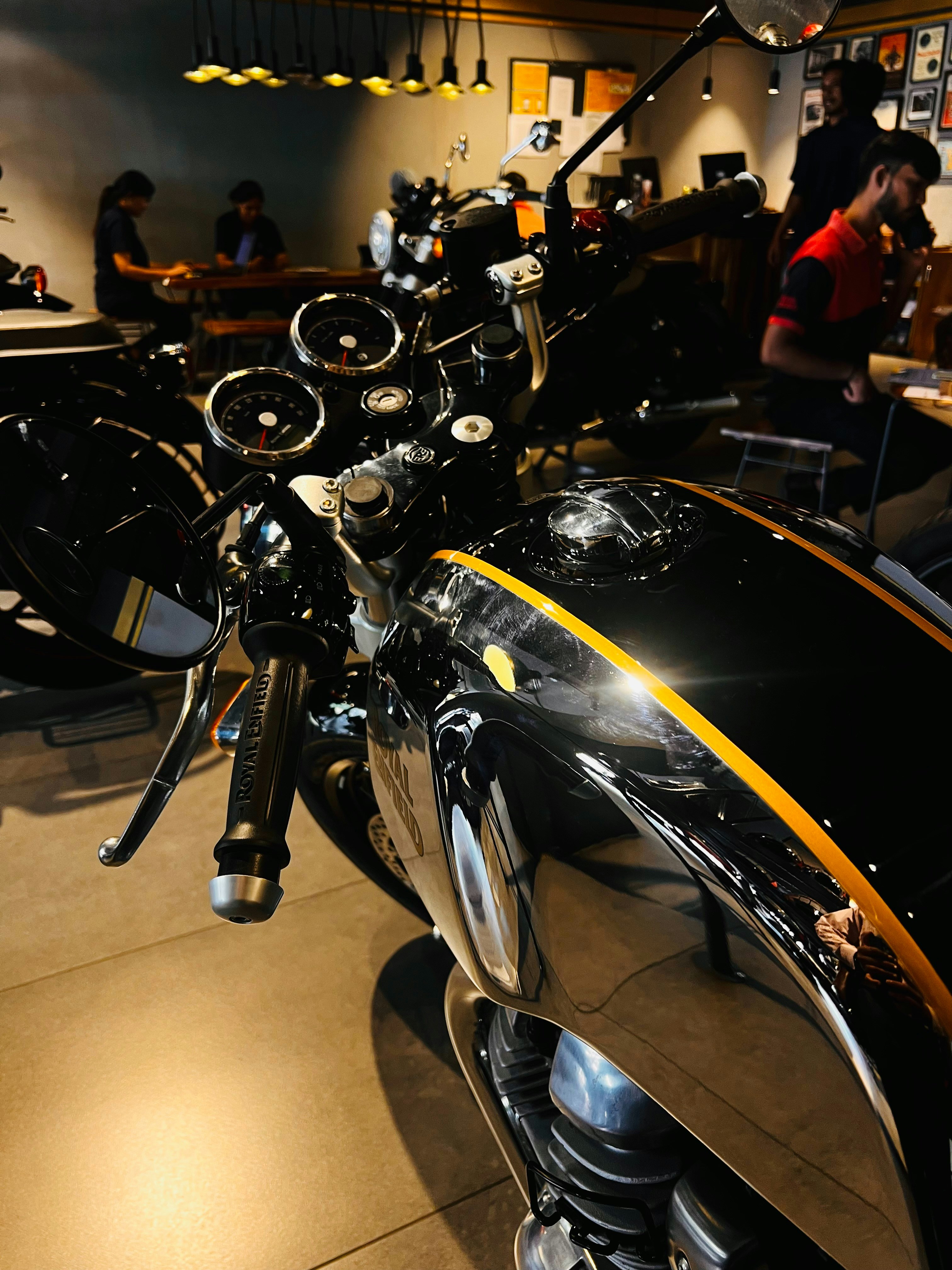 Chrome Crest in a Café-Style Showroom: Close-Up of a Vintage Motorcycle
