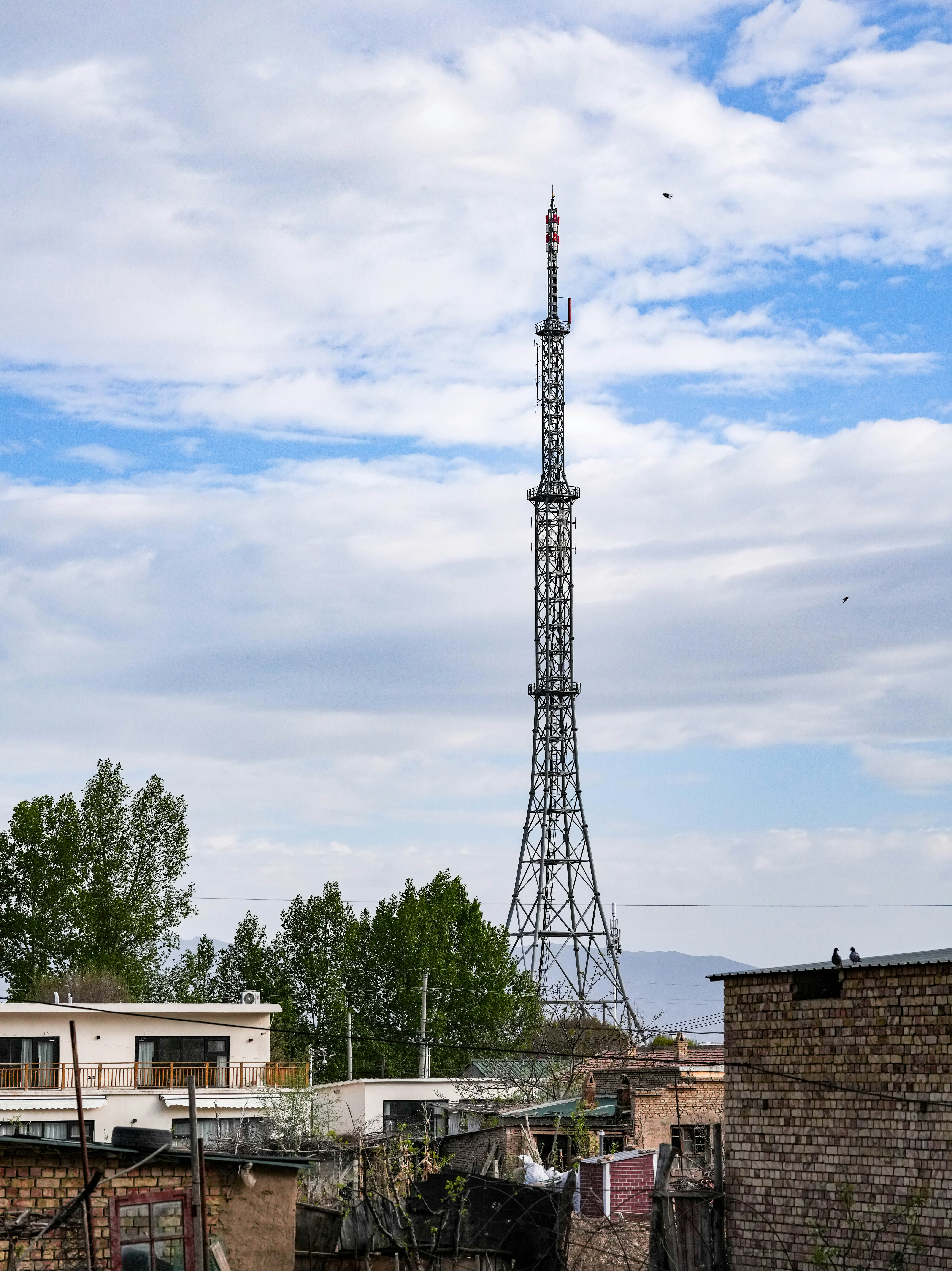 A very tall tower towering over a city photo – Free Building Image on ...