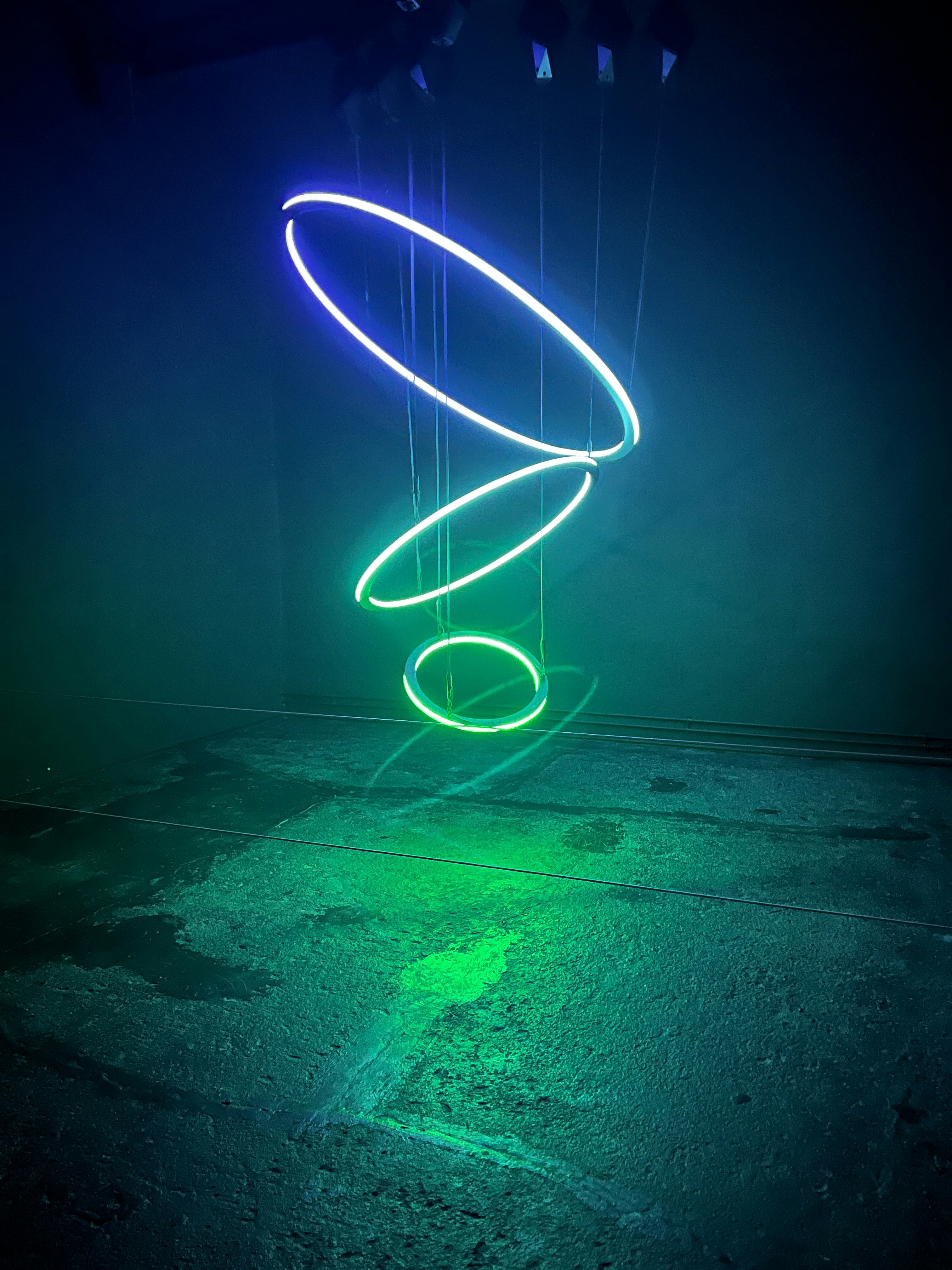 Neon Helixes: A Suspended Spiral Dance in Blue-Green Light