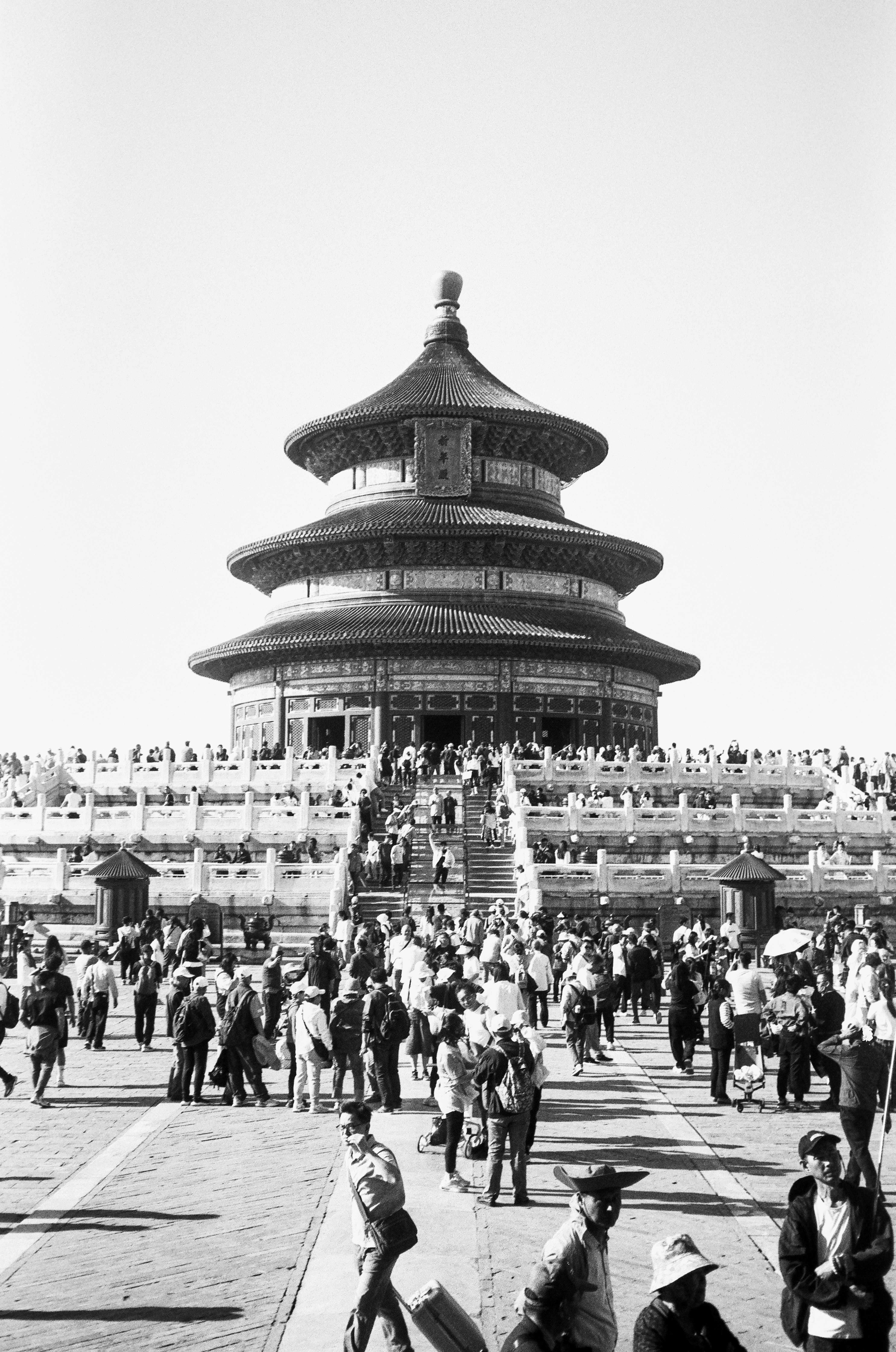 A crowd of people walking around a large building photo – Free Film ...