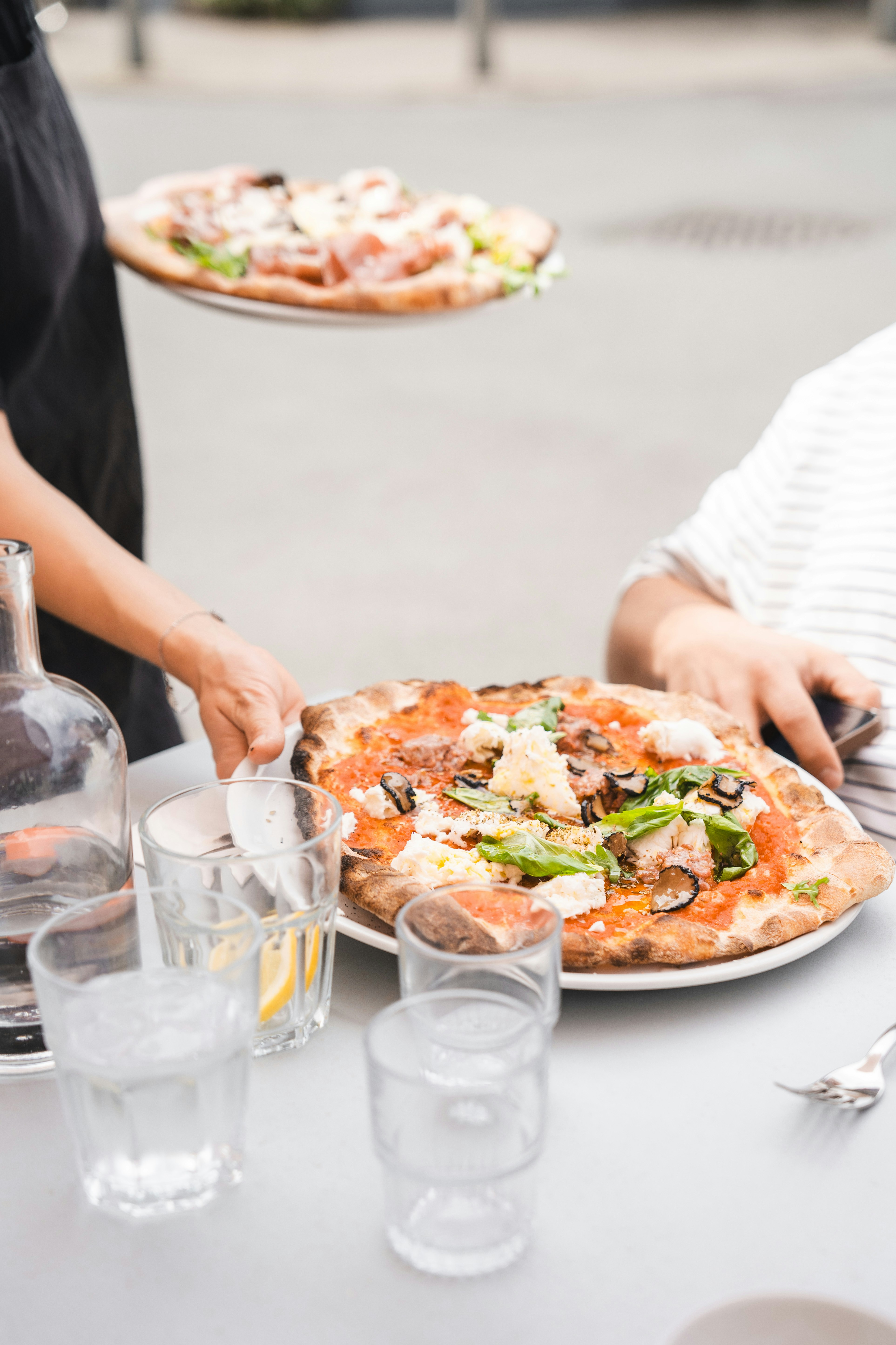 A couple of people that are eating some pizza photo – Free Food Image ...