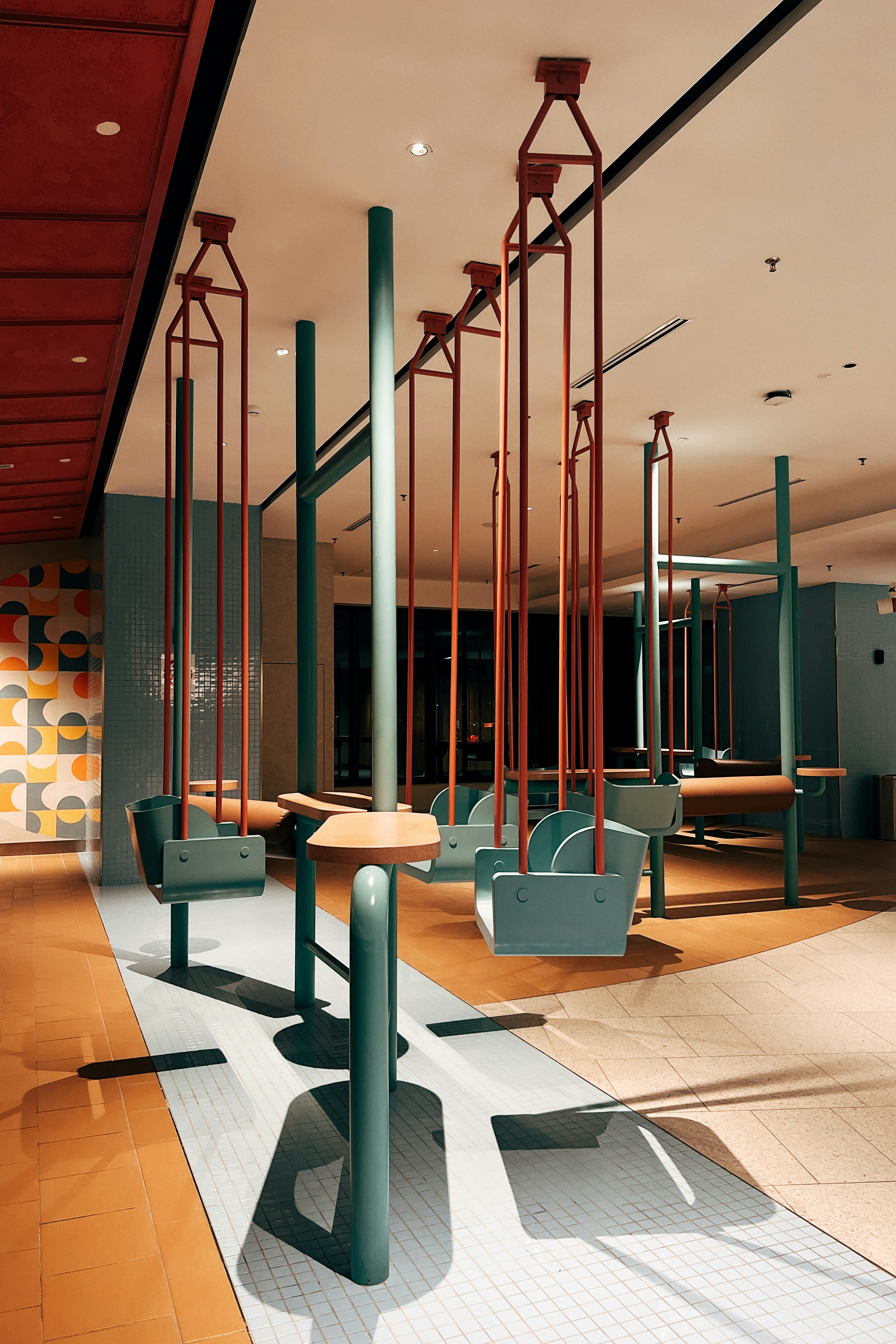 Colorful Swing Set in a Retro-Modern Atrium