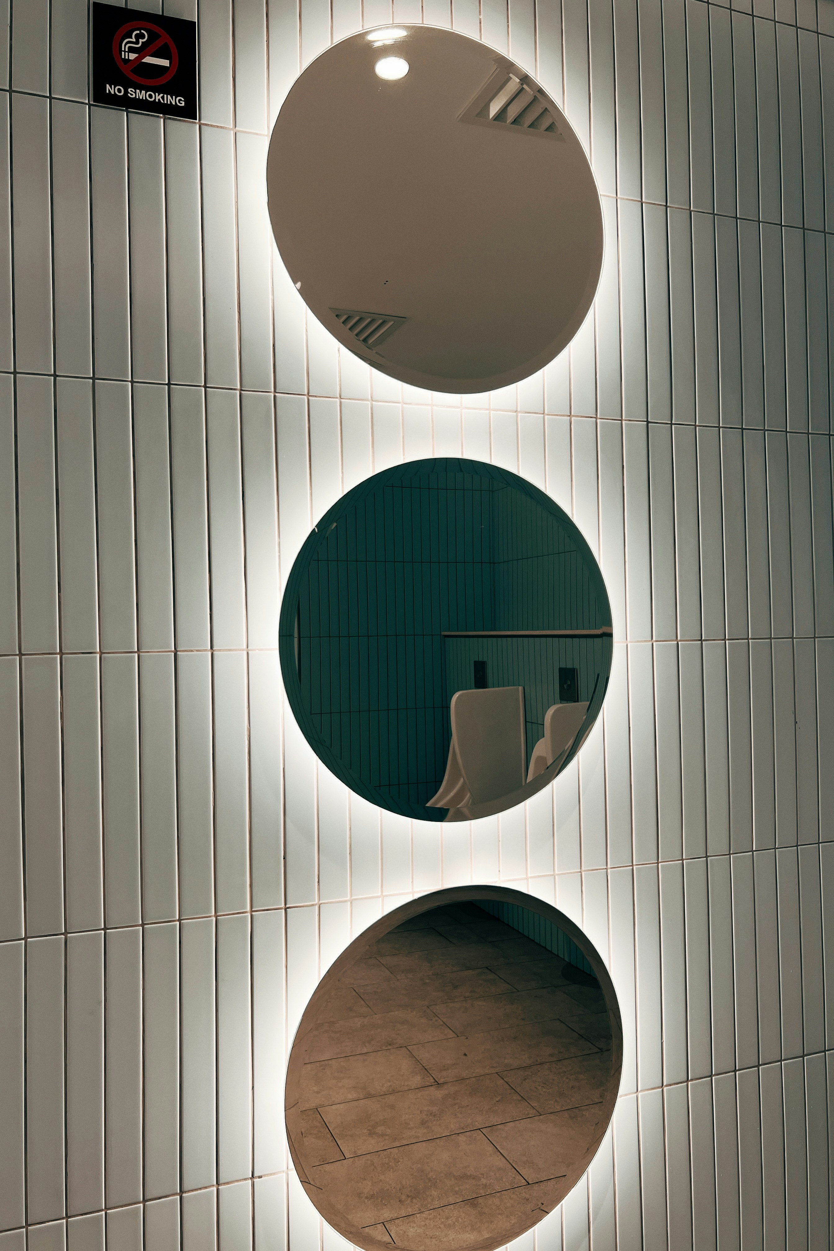 A bathroom with three round mirrors on the wall photo – Free Interior ...