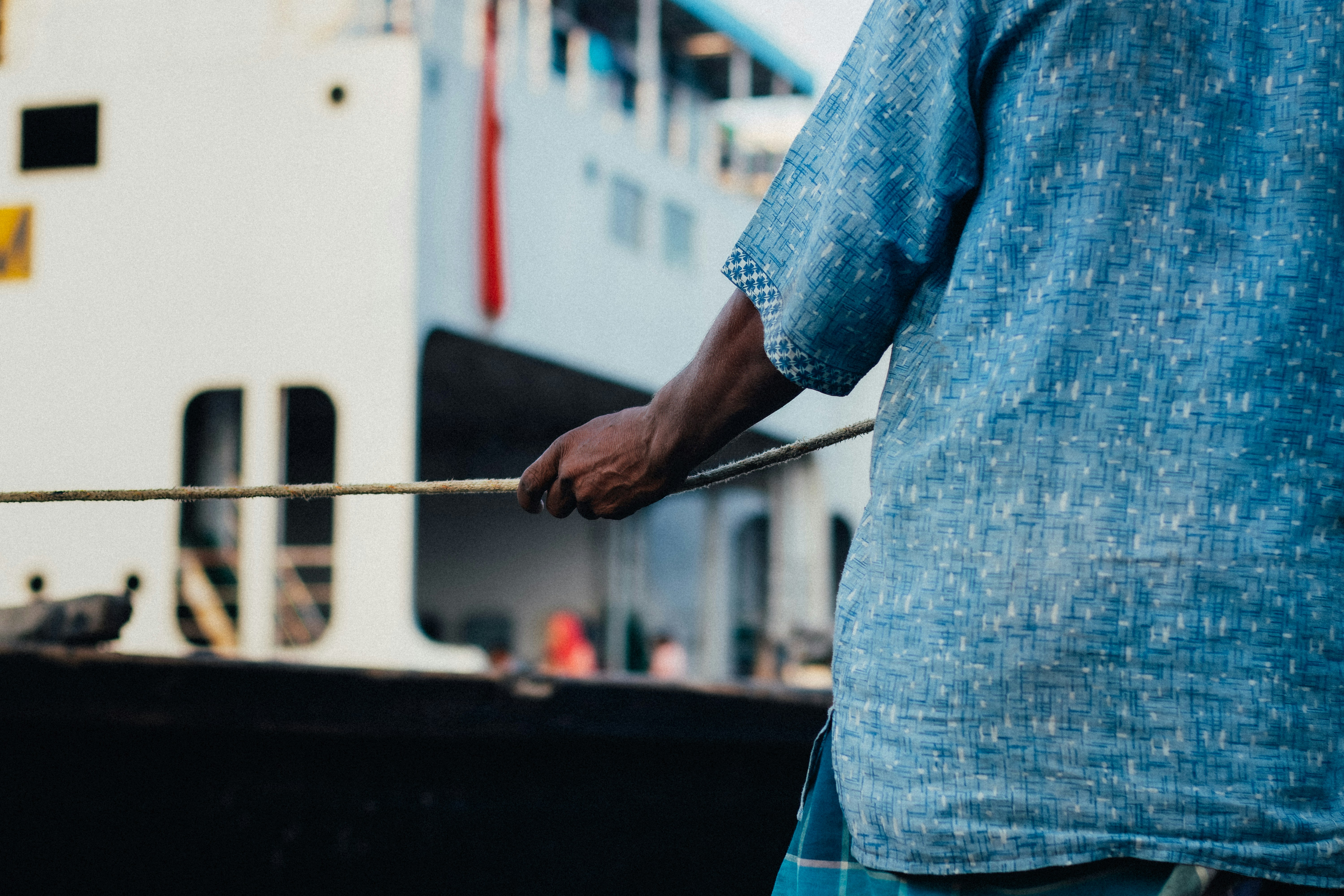 Blue-Stripe Shirt and Rope at Port: The Human Element in Transit
