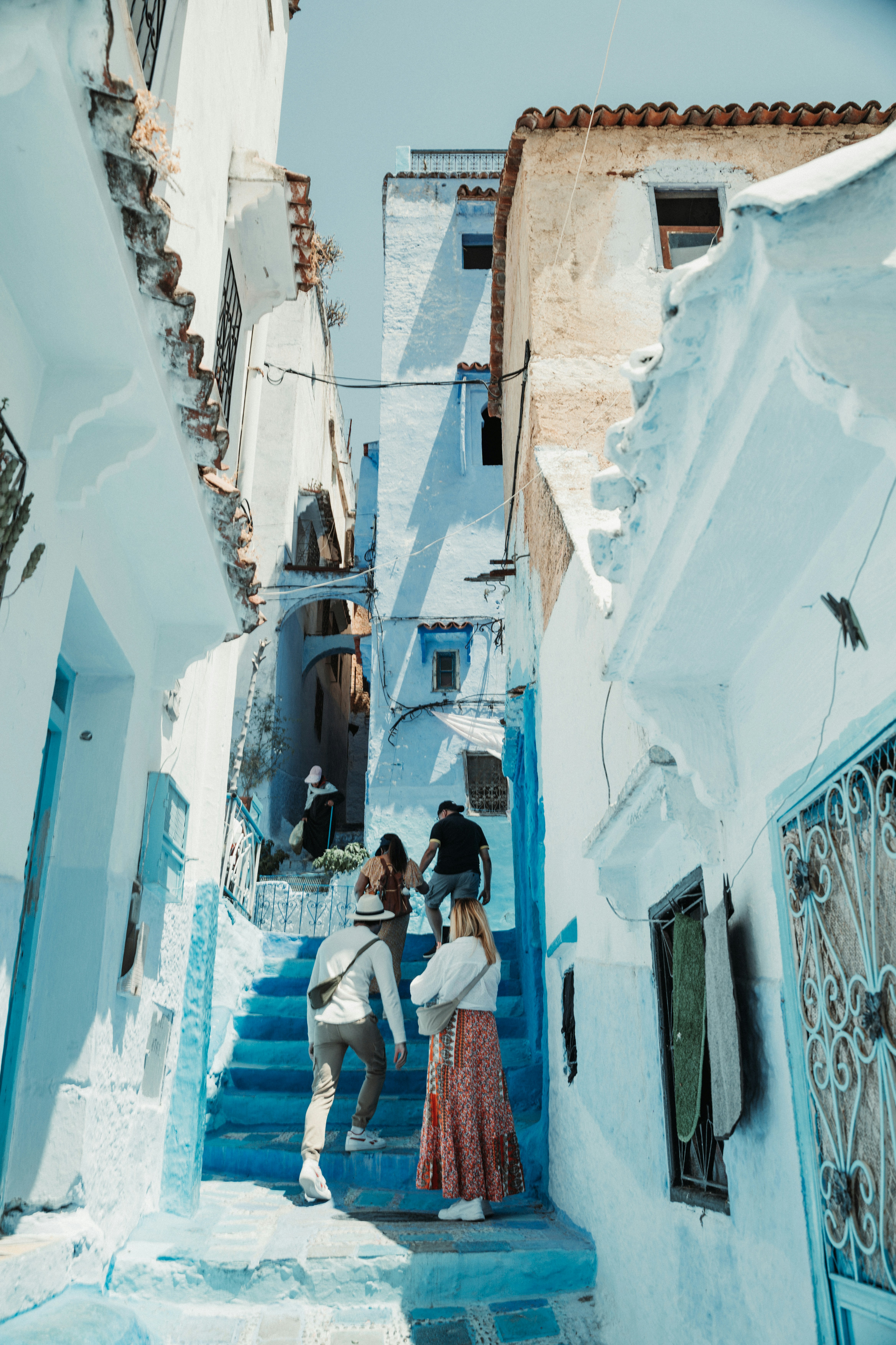 Azure Staircase: Travelers Ascend Chefchaouen’s Sky-Blue Lane