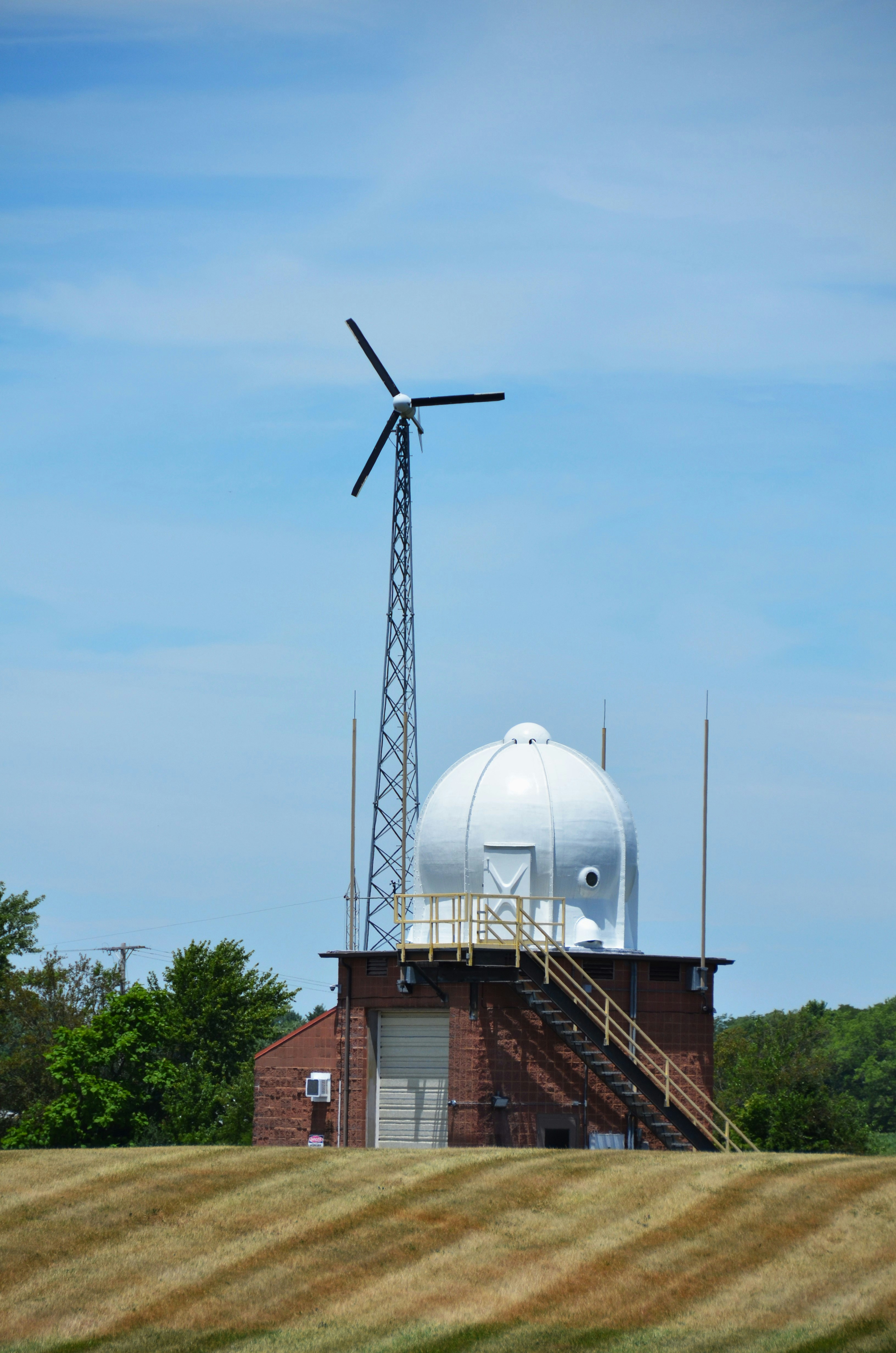 Windmill Sentinel: A Wind Turbine Overlooking a Brick Observatory