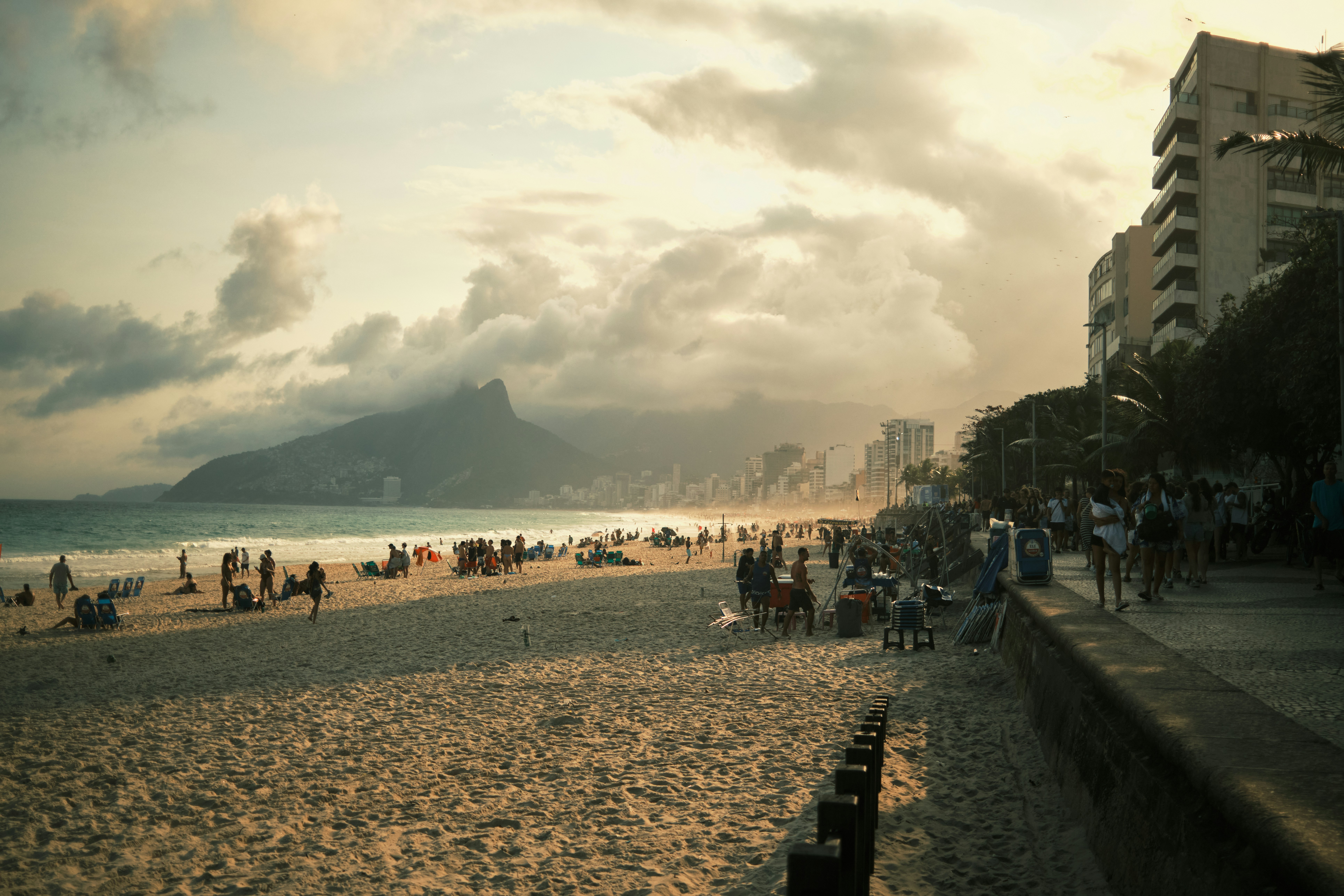 Golden Hour Convergence: Crowds, Coastline, and a Distant Peak