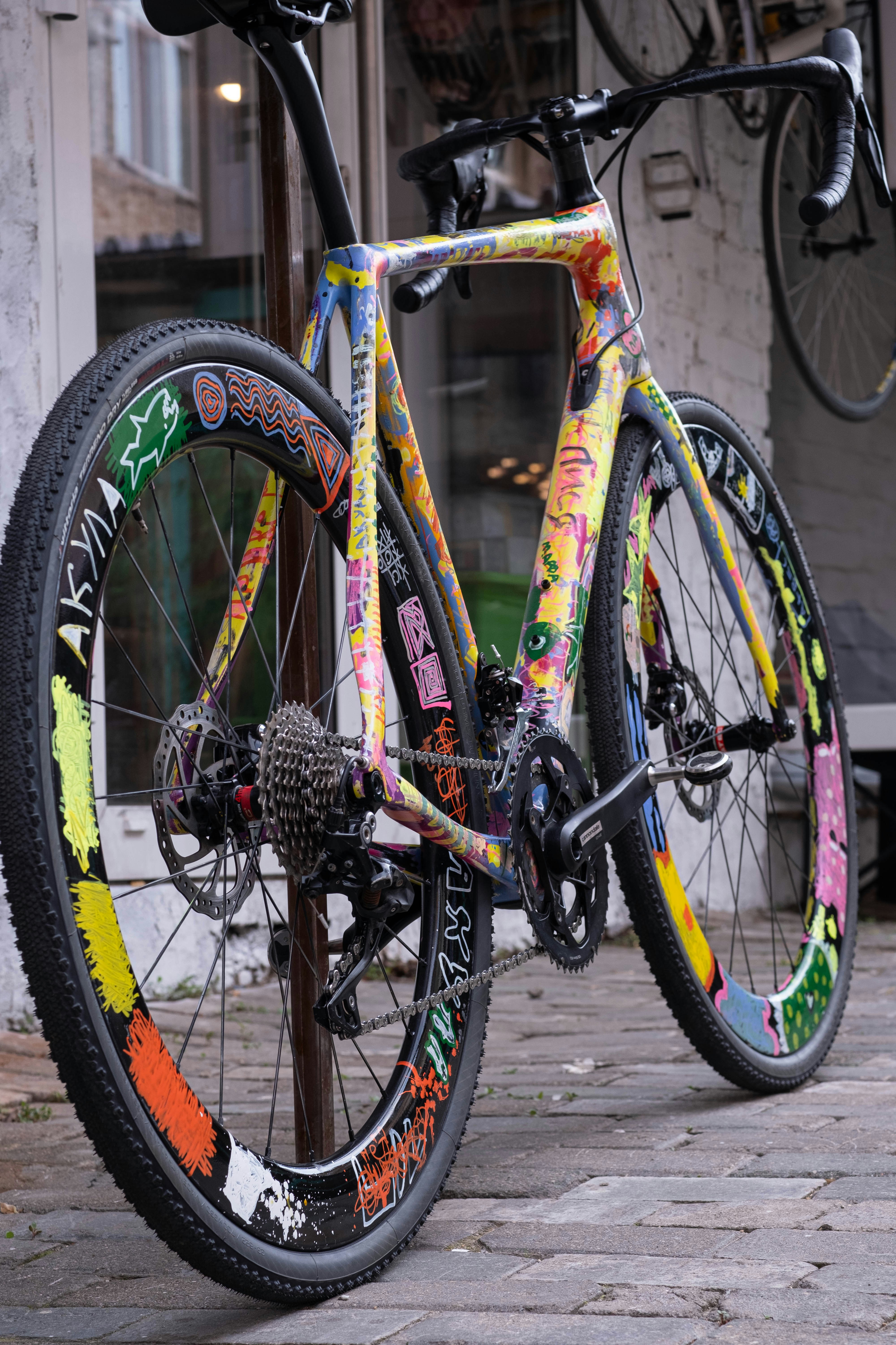 Chromatic Cyclone: A Graffiti-Clad Road Bike Anchored on Cobblestones