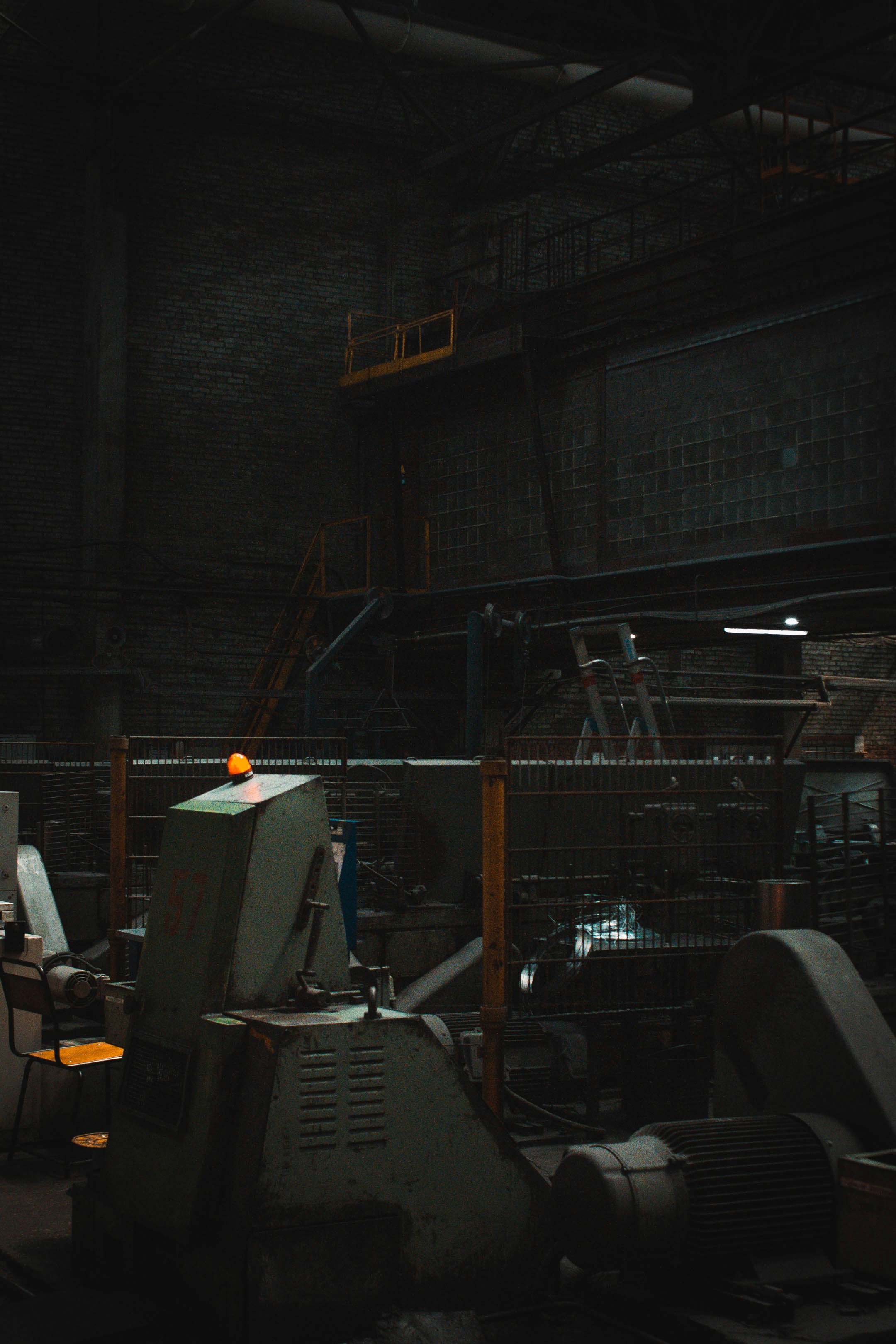 A man standing in front of a machine in a factory photo – Free Factory ...