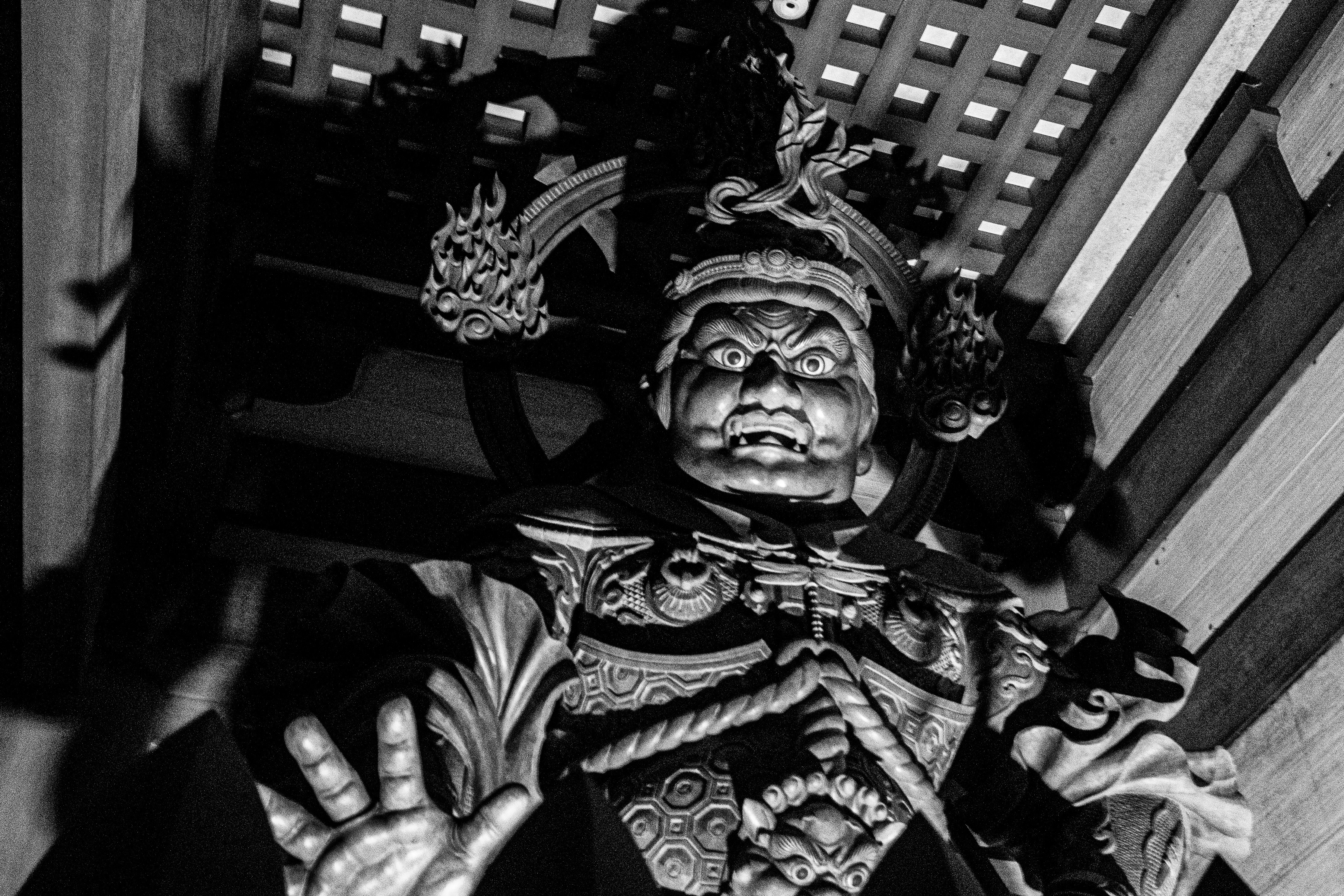 Eyes of the Guardian: A Looming Shogunate Figurine in Dim Light
