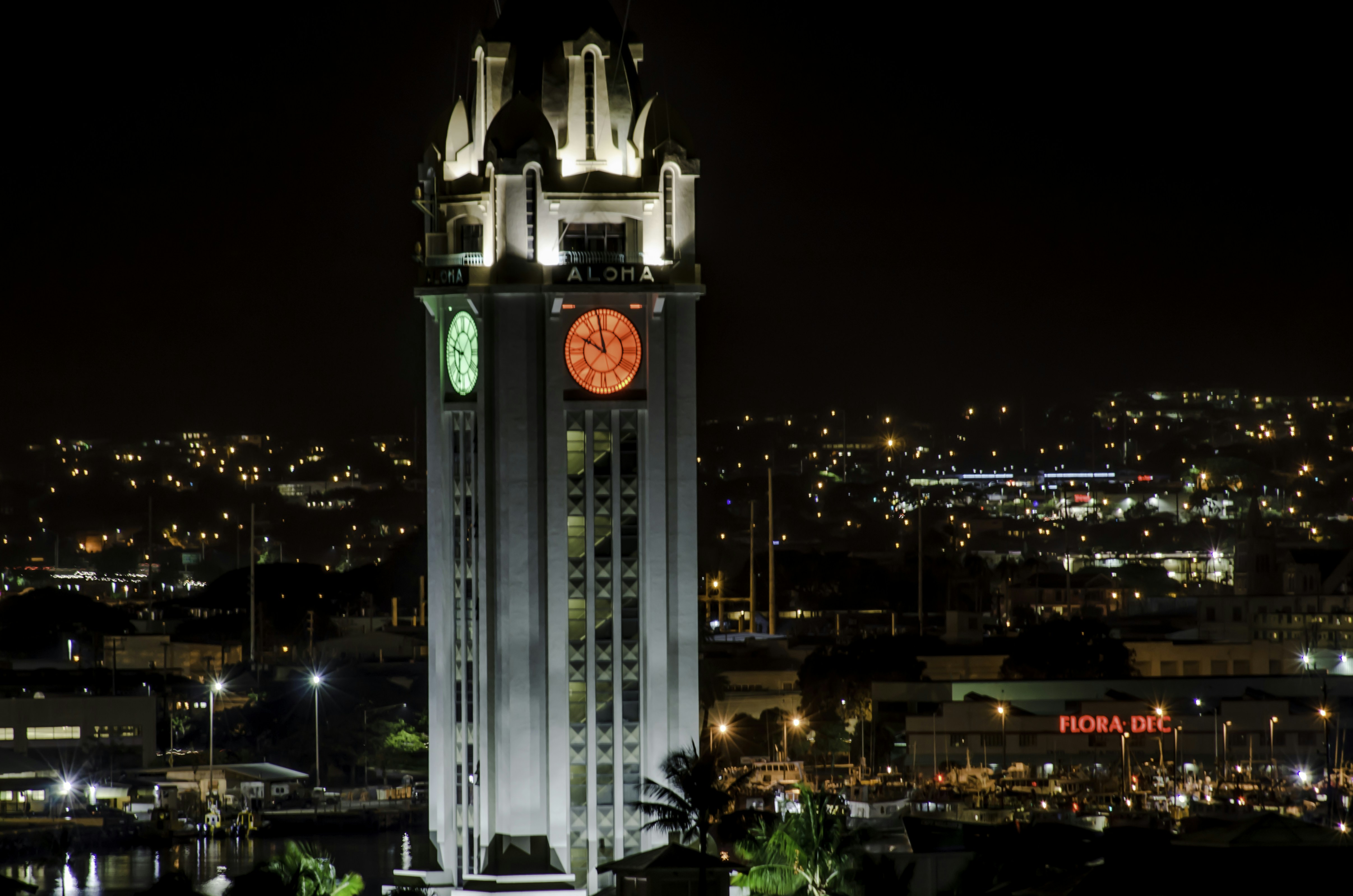 Twin-Tone Clock Tower Over a Night-Lit City Skyline