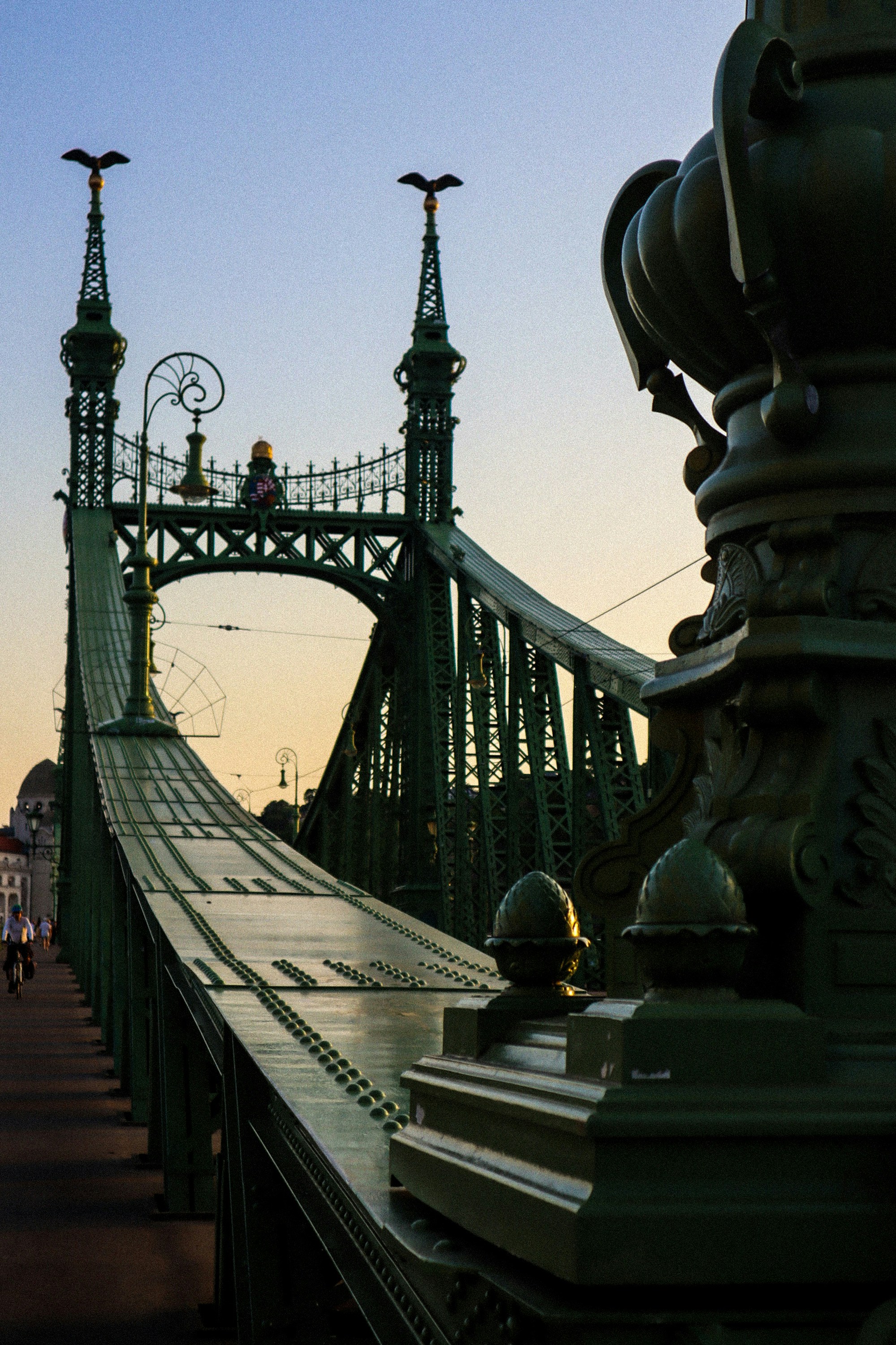Sunset on a Verdant Beacon: A Lone Figure on Budapest's Liberty Bridge