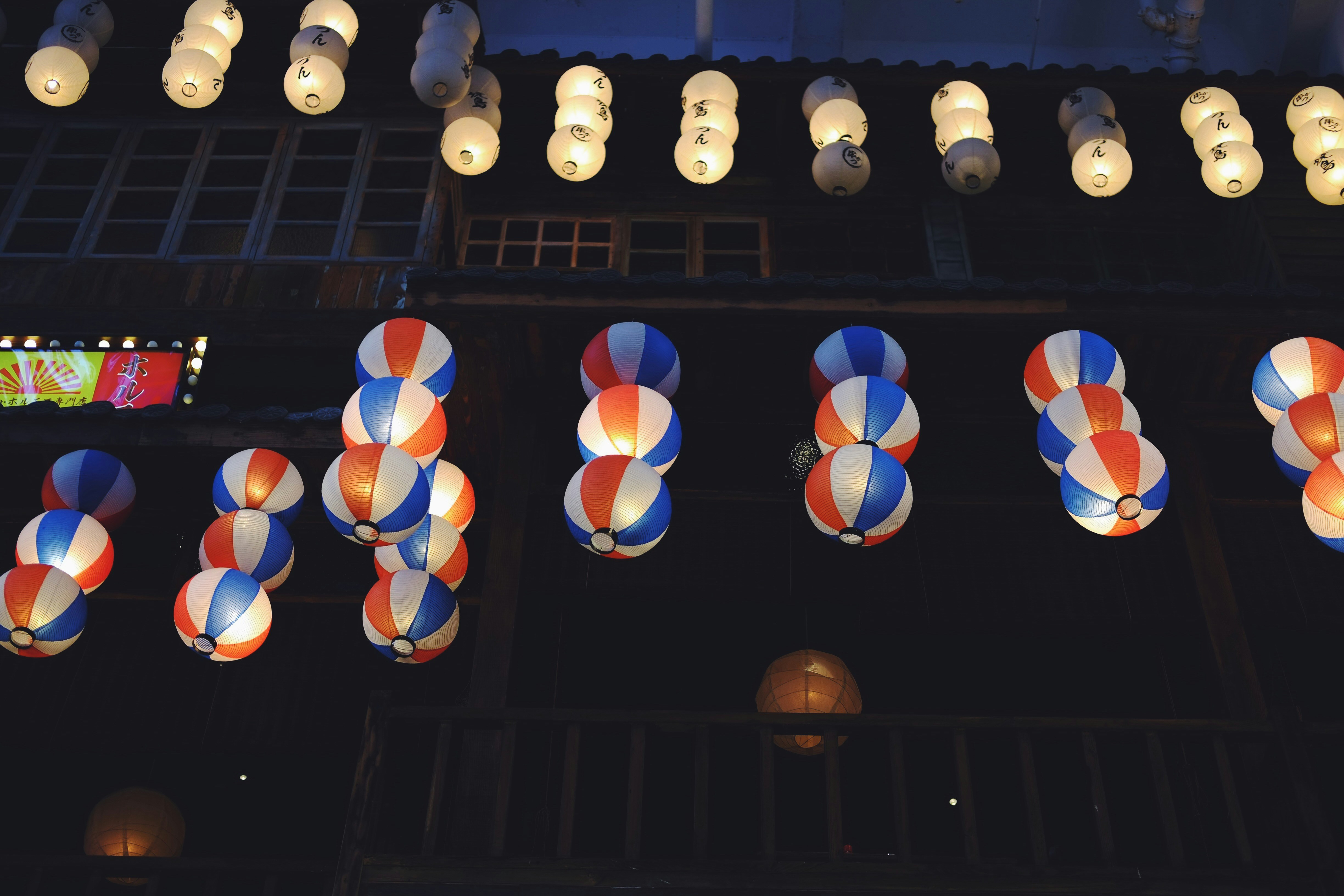 A bunch of lights hanging from the ceiling of a buildingmonk 333