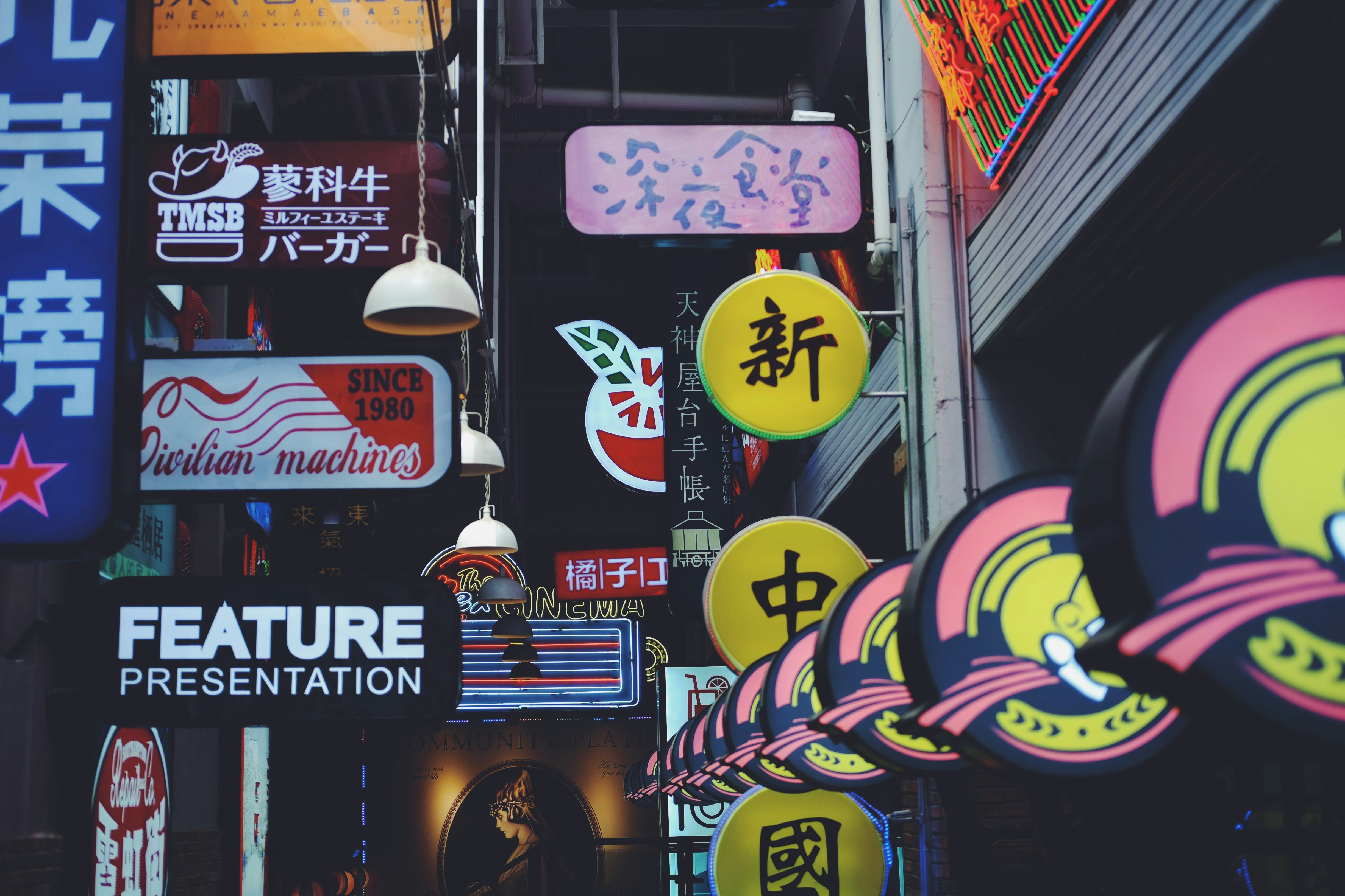 A city street filled with lots of neon signsmonk 333