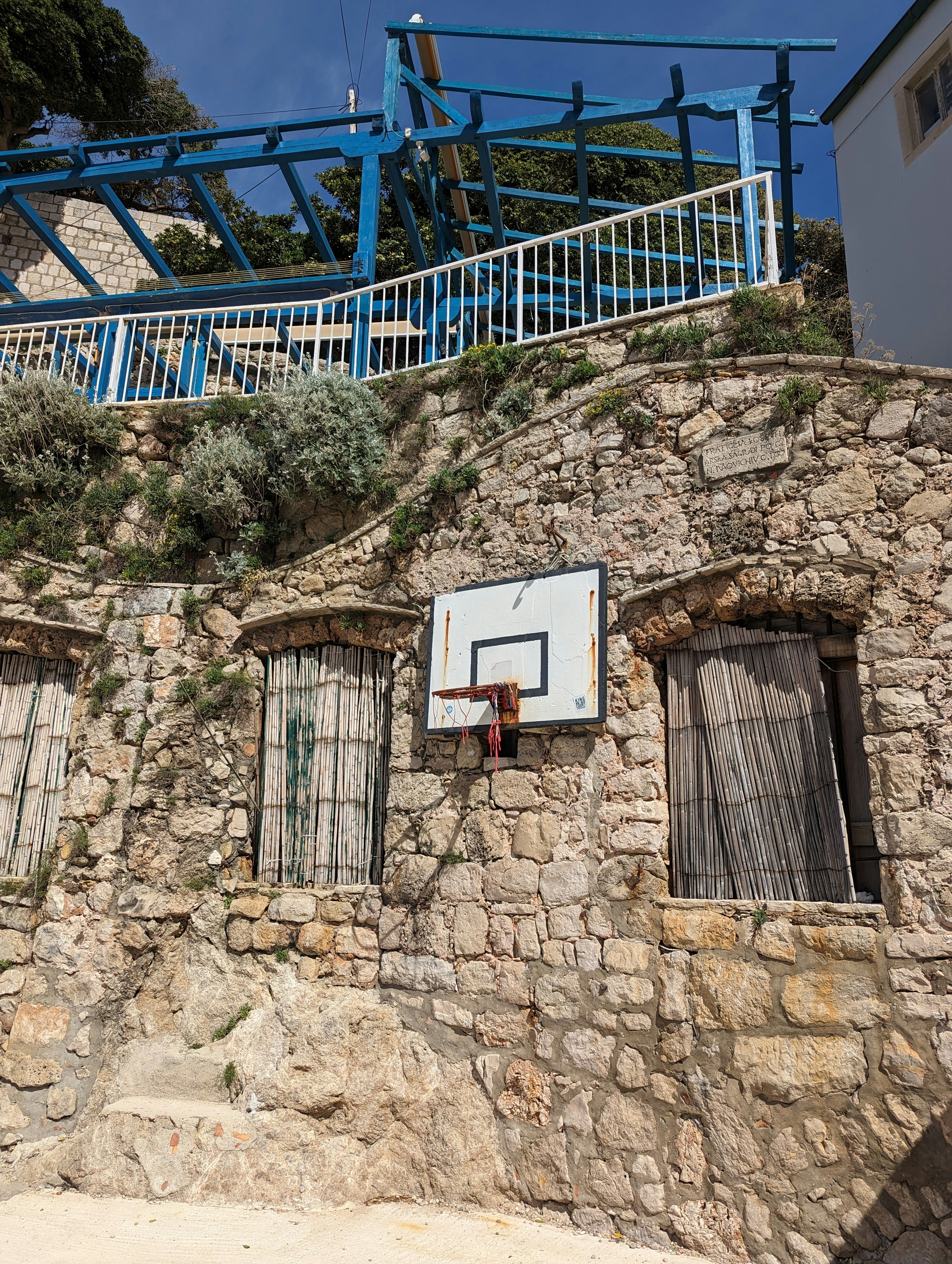 Basketball Hoop on a Weathered Stone Facade