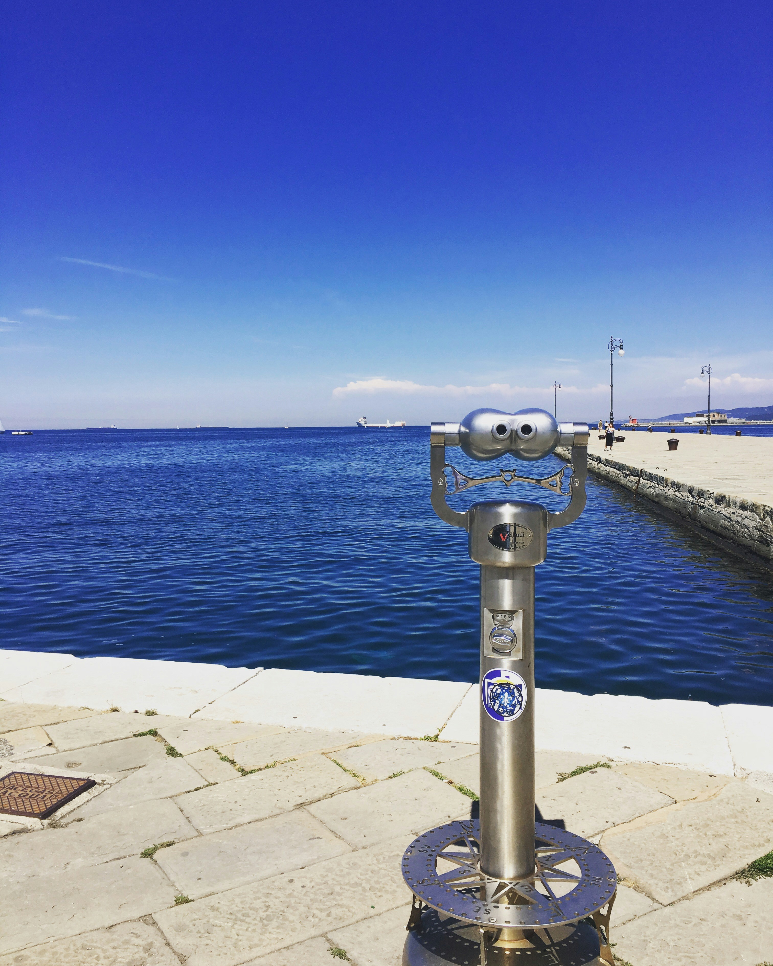 Harbor Viewfinder: Stainless Telescope Pointing Toward a Calm Sea