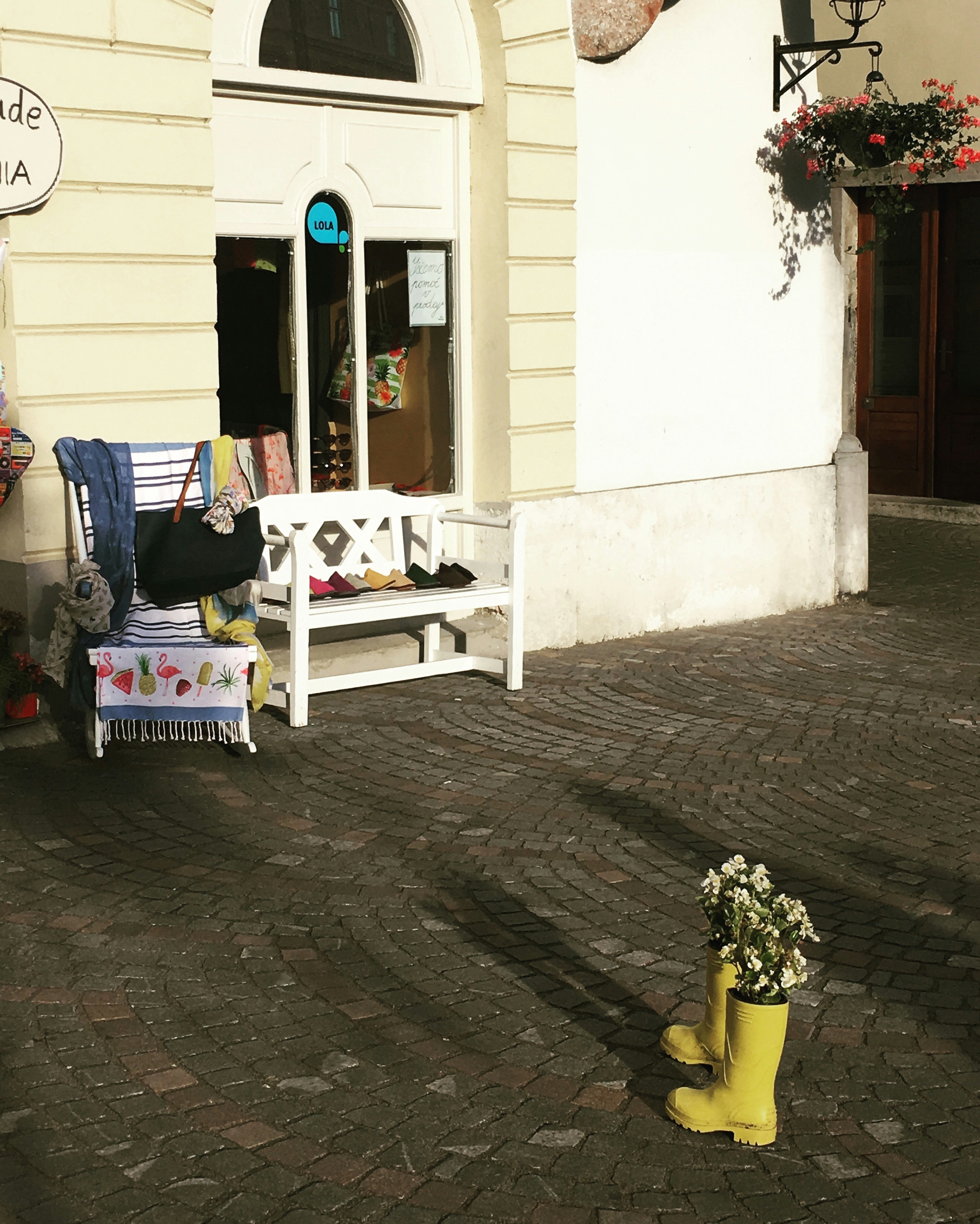 Bright Yellow Boots Guard a Quiet Cobblestone Street