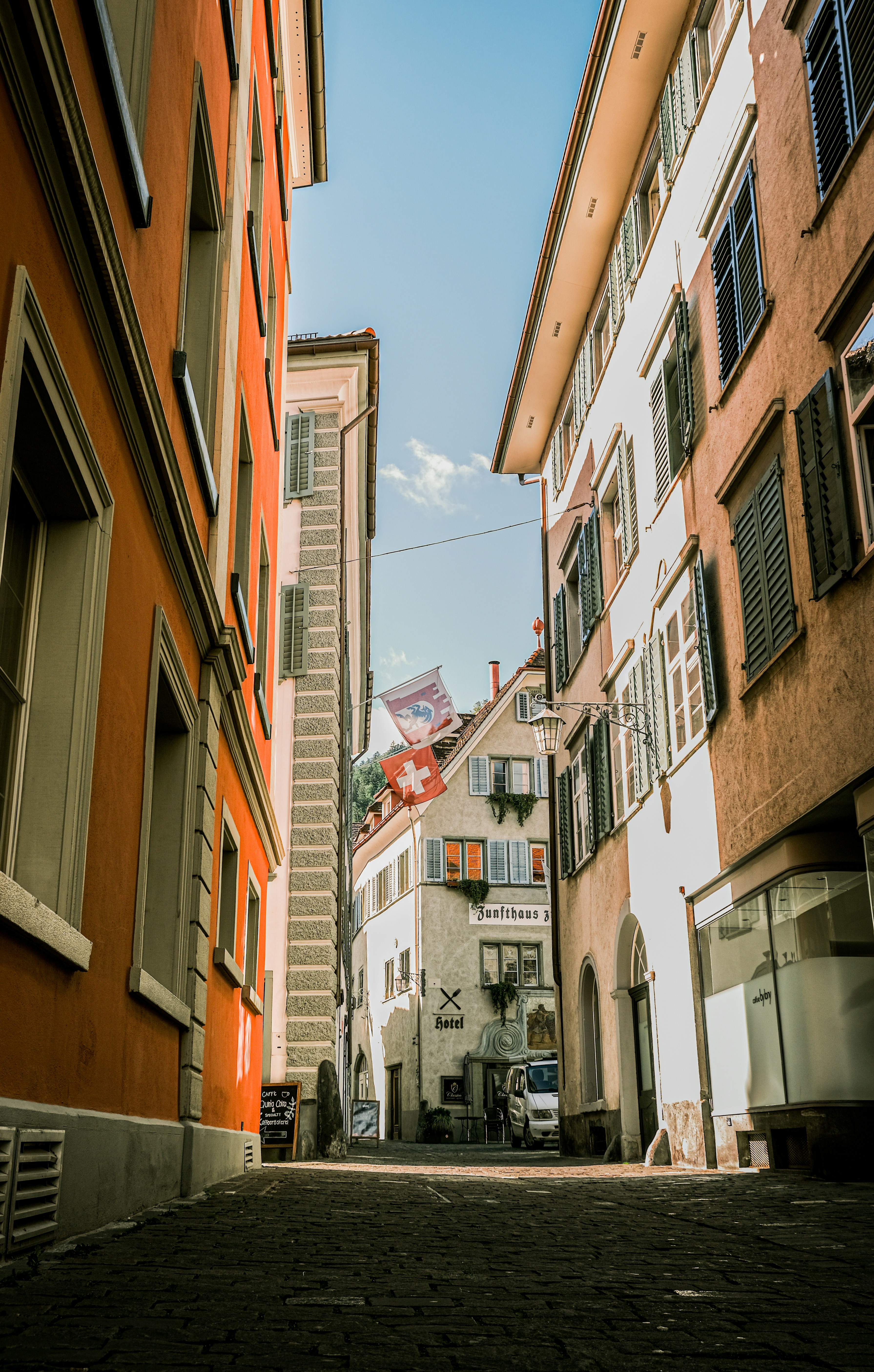 A narrow city street with buildings on both sides