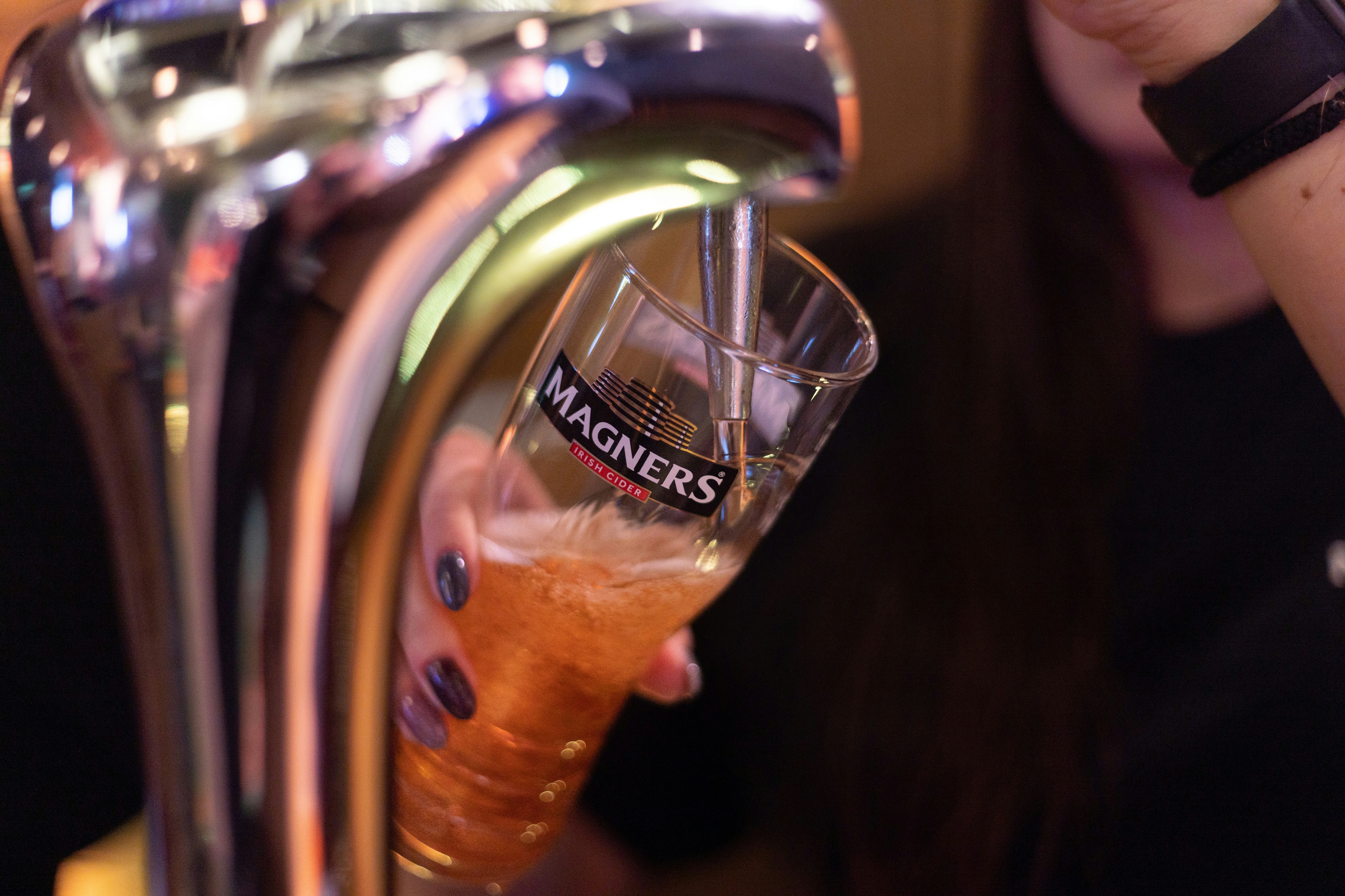 Amber Cascade at the Tap: Magners in Focus Beneath Chrome Arches