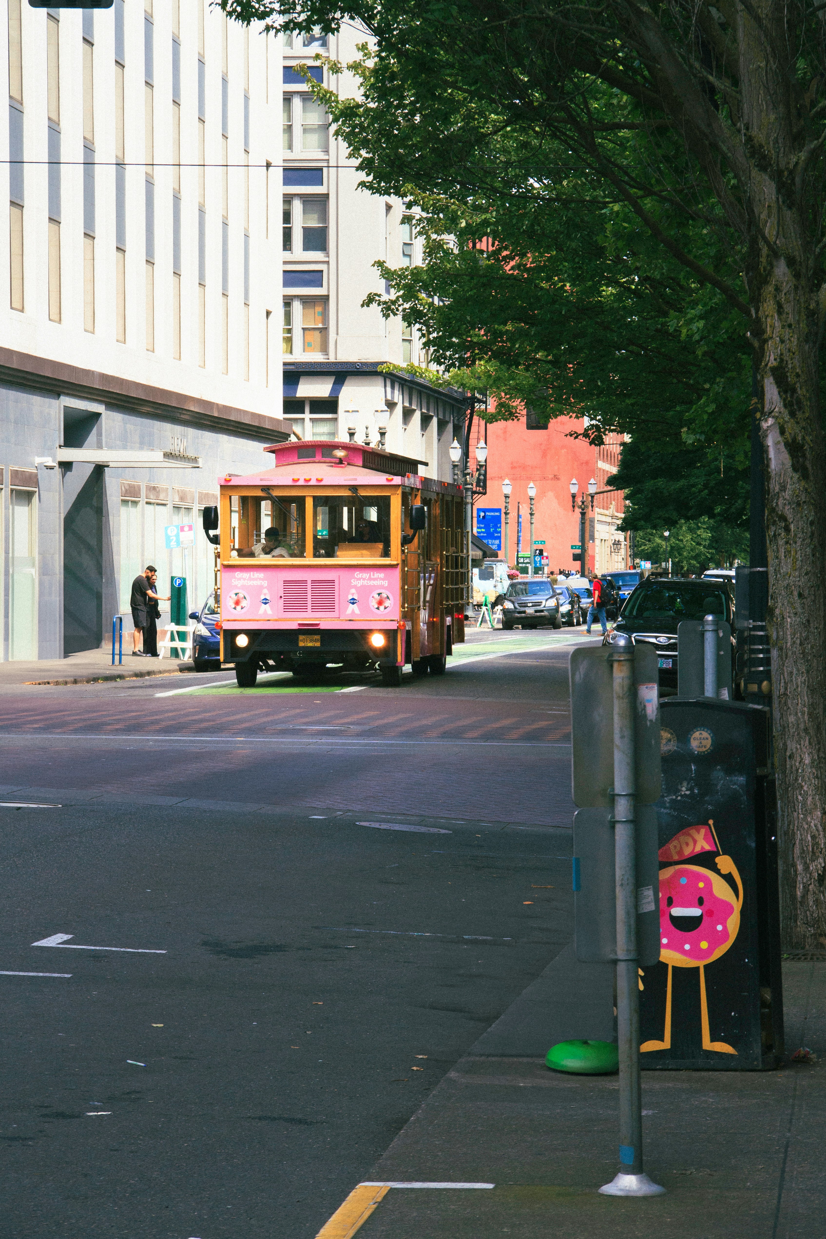 Pastel tram threading a sunlit city street