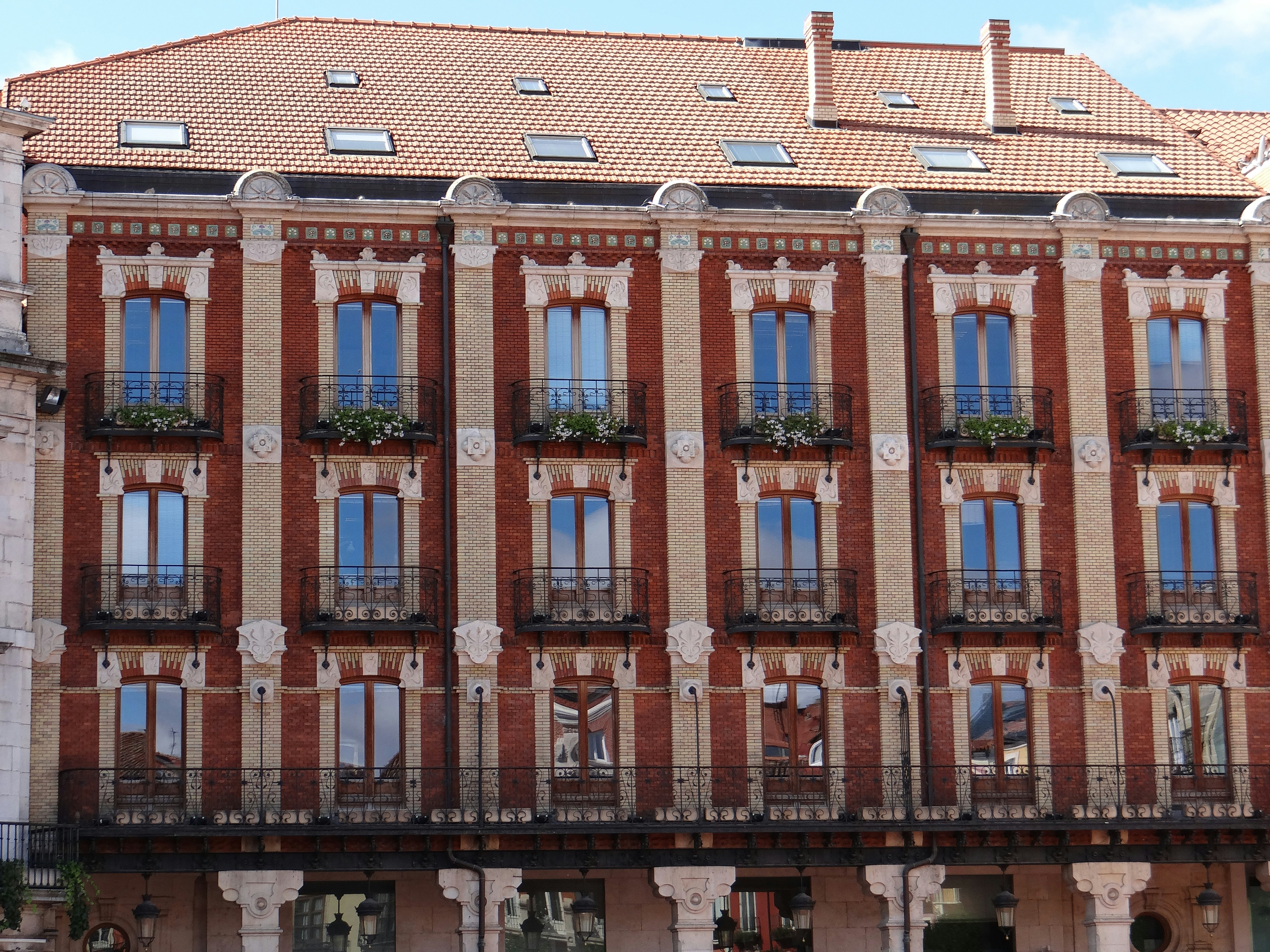 Brick-and-Iron Elegance: Row of Windowed Facades