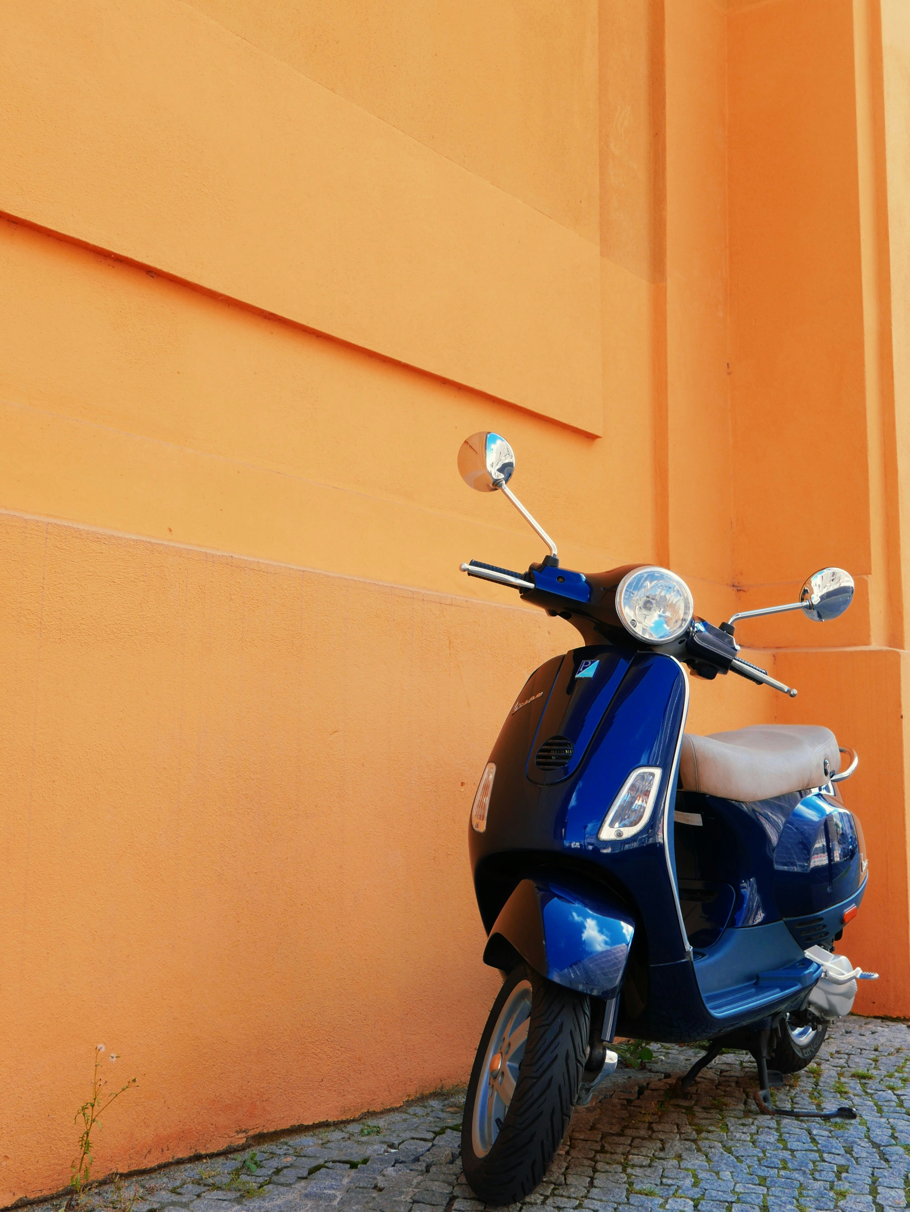 Blue Scooter Framed by a Warm Orange Wall