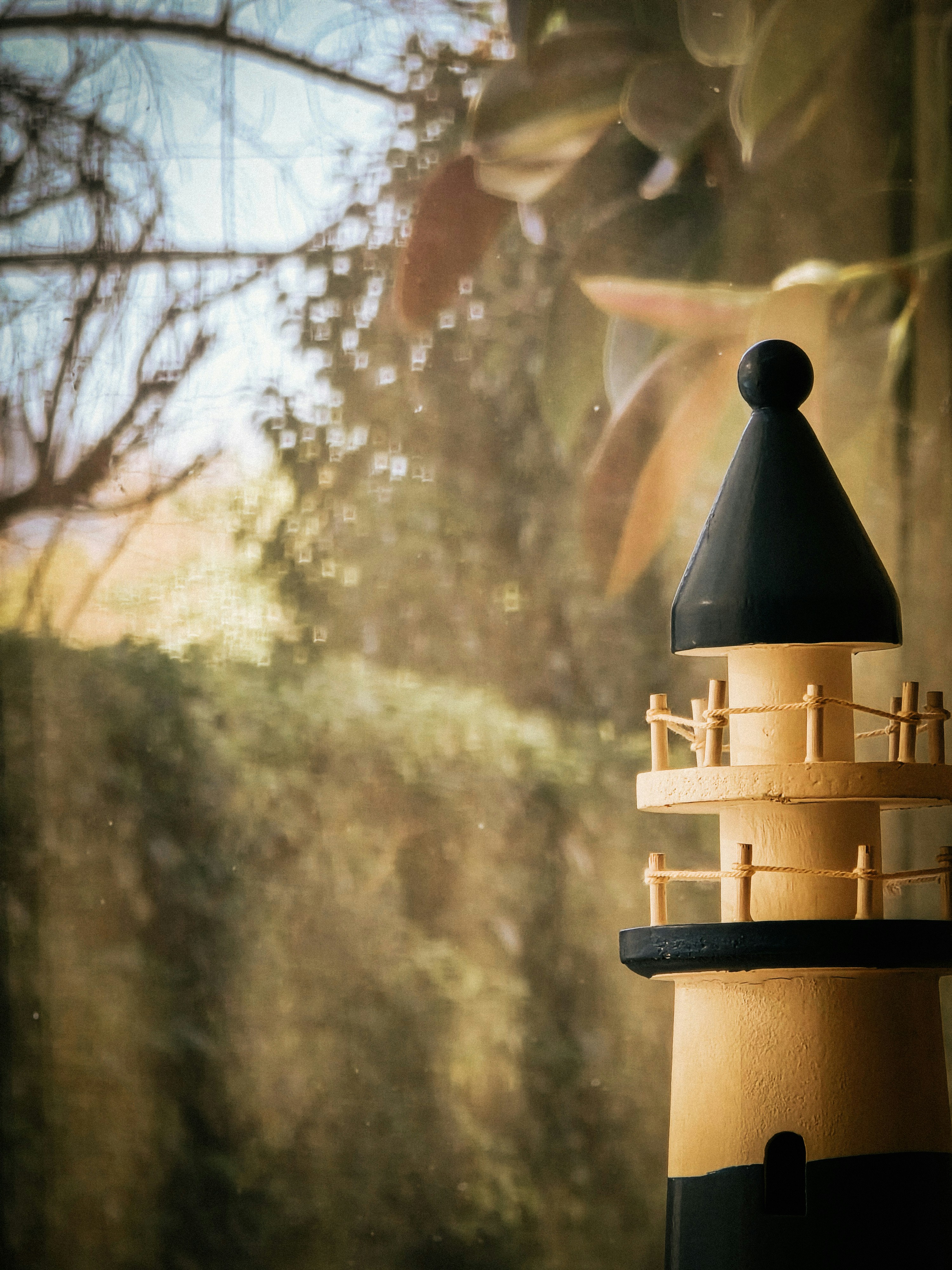 Mini Lighthouse in Soft Backlight: A Wooden Tower with Gentle Bokeh