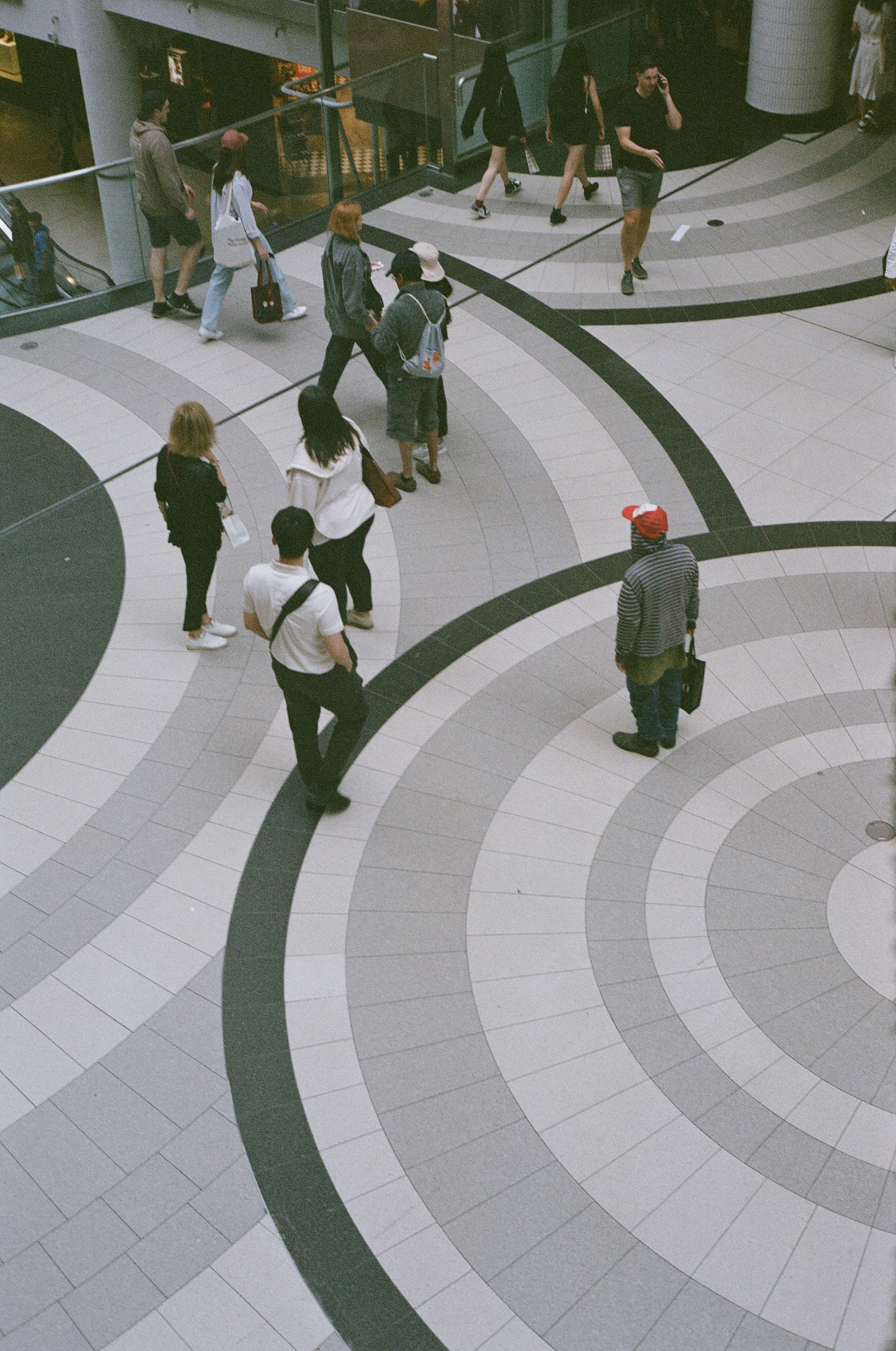 A group of people walking around a building photo – Free People Image ...