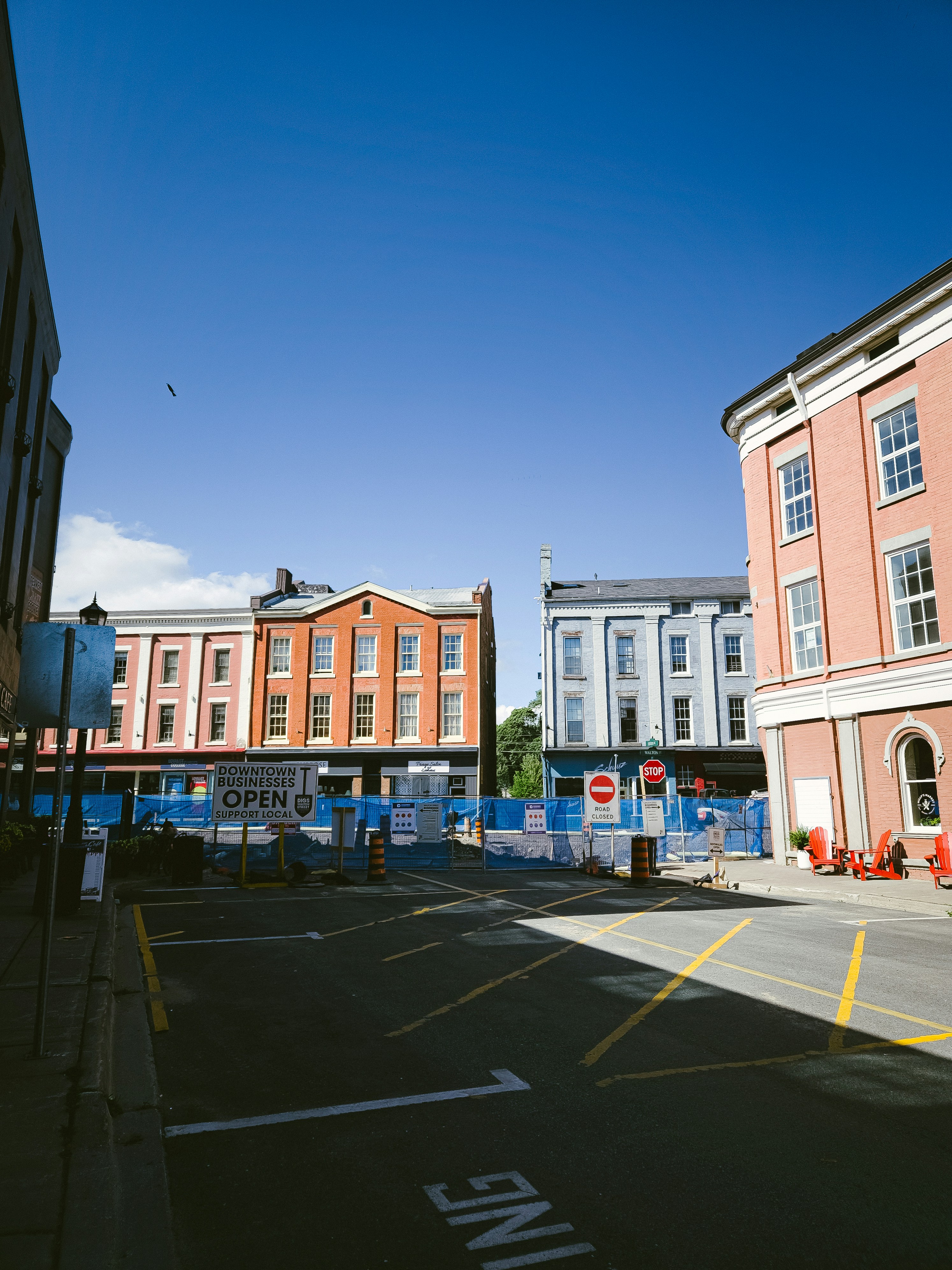 A row of buildings sitting next to each other on a street photo – Free ...