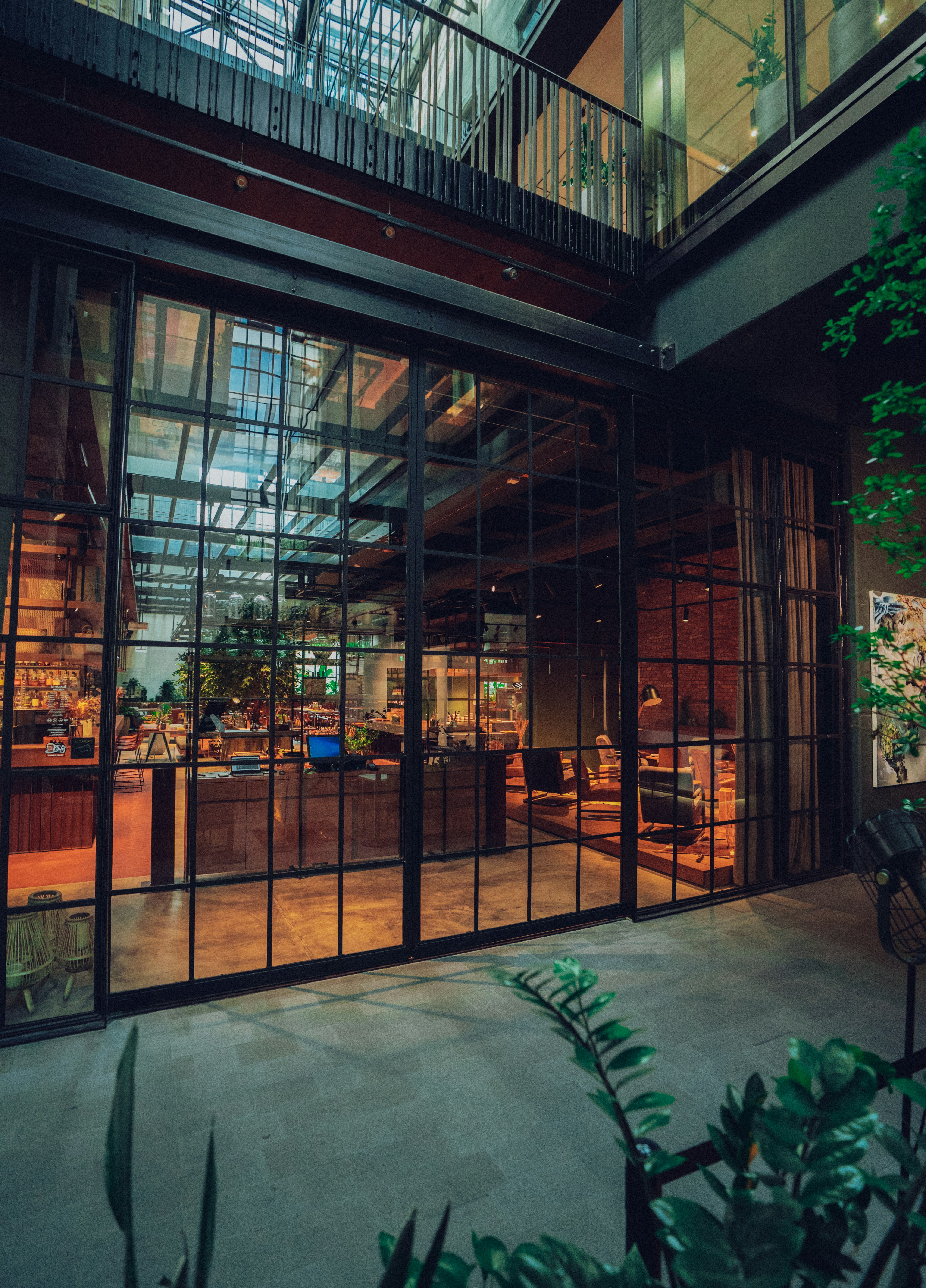 Modern interior design | A building with a lot of windows and plants