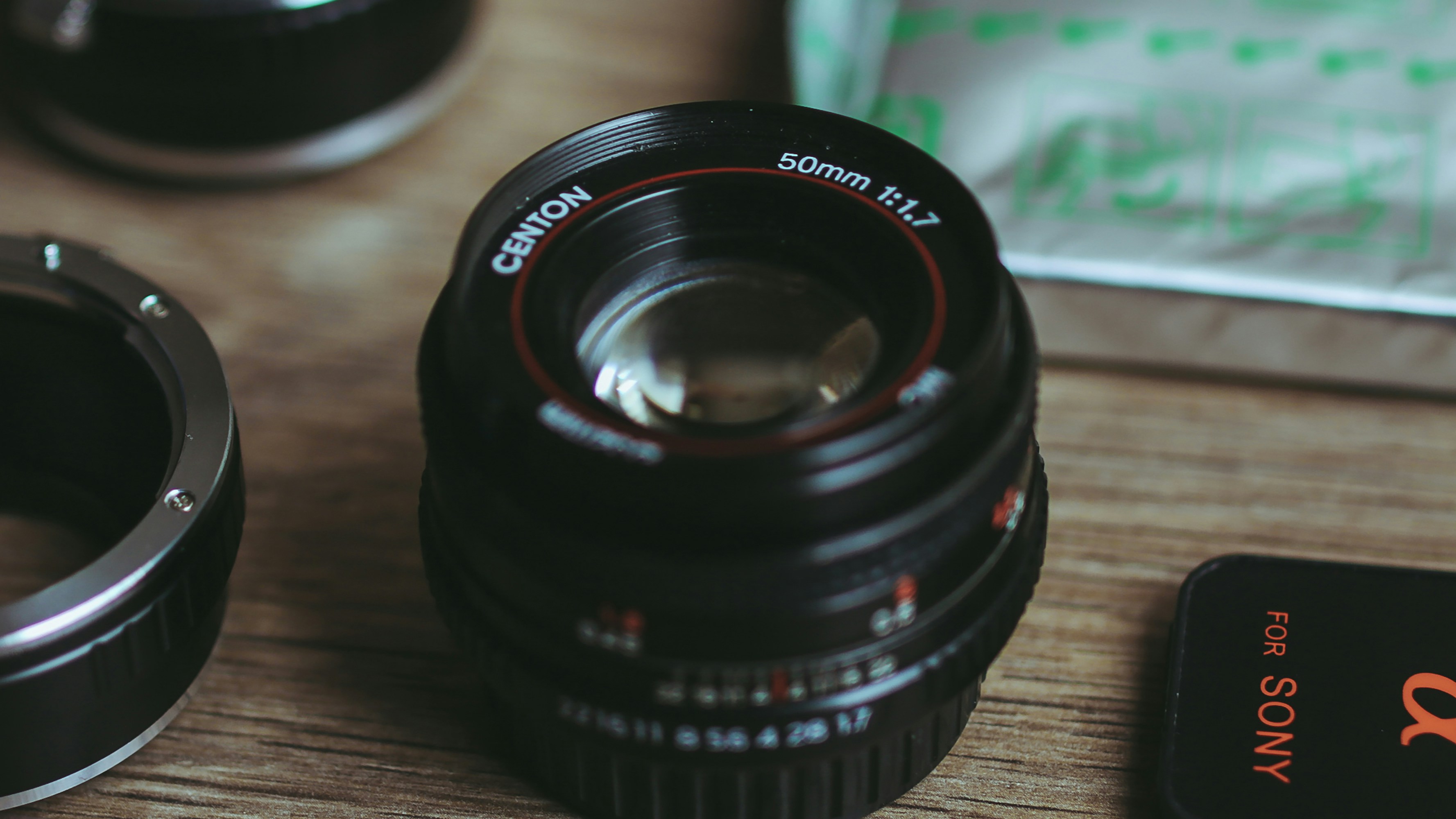 A camera lens sitting on top of a wooden table photo – Free Lens Image ...