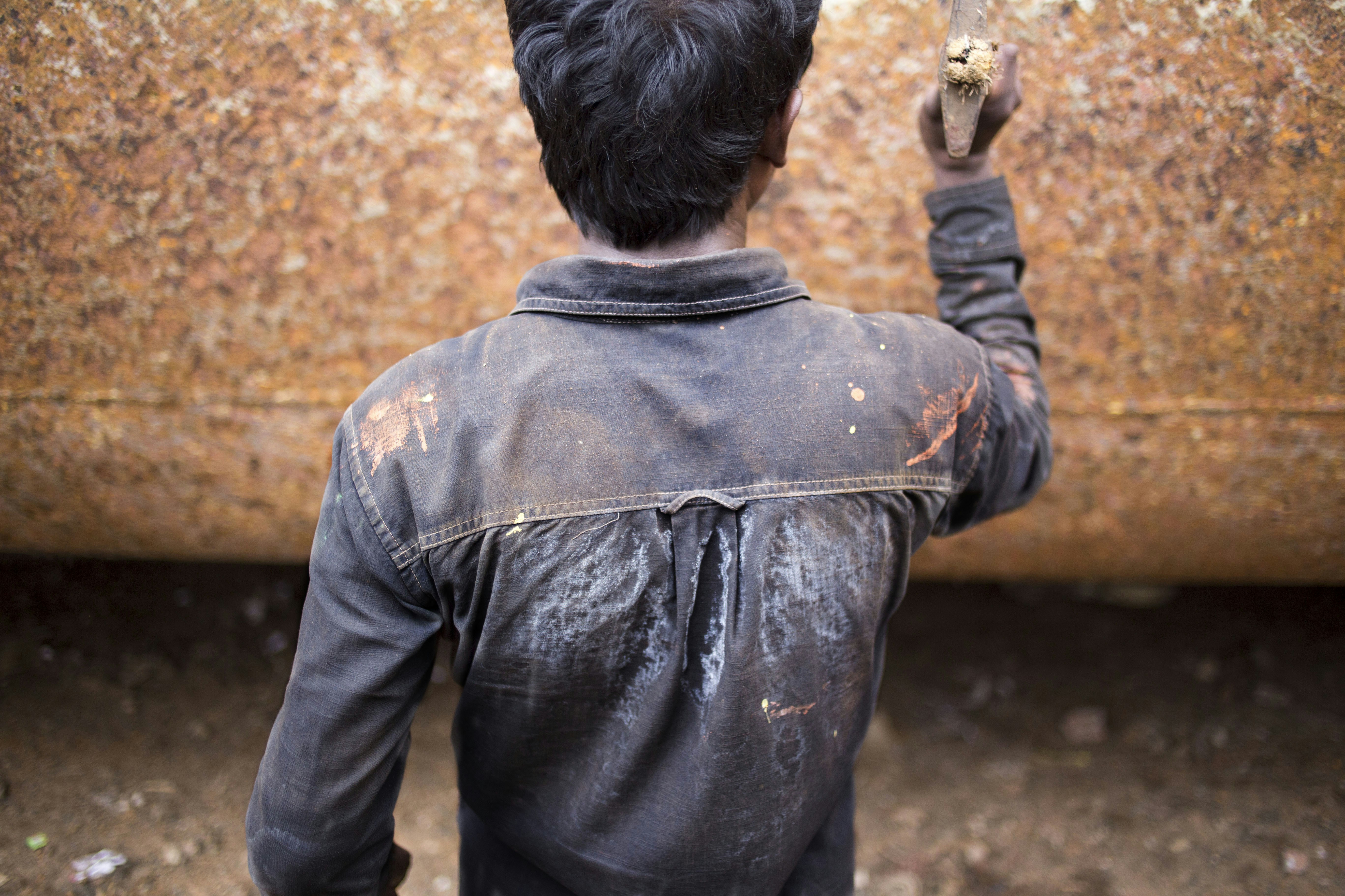 Behind the Rust: A Raised Hand Against an Industrial Backdrop