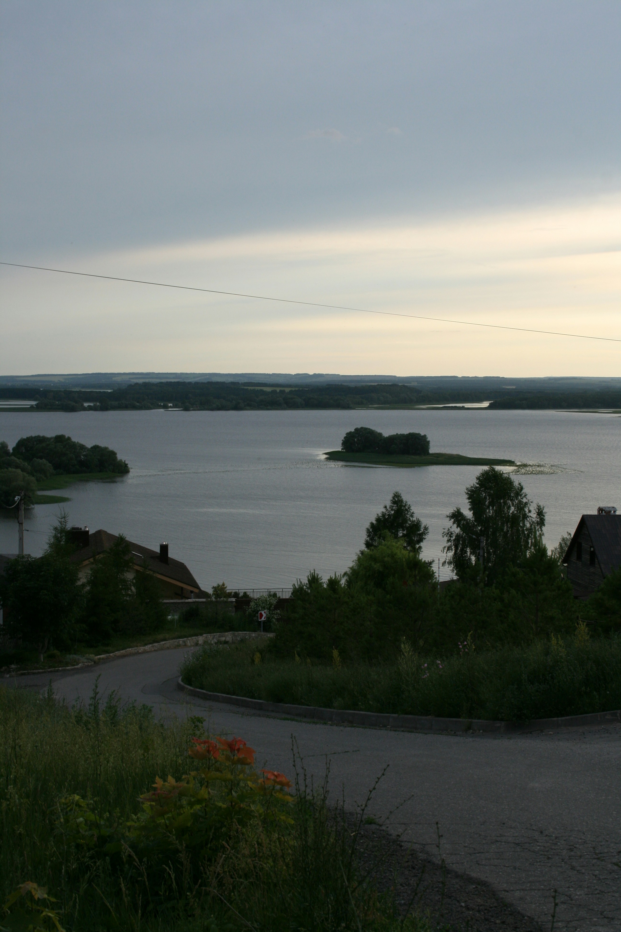 Dusk Over the Lake: A Quiet Isle Framed by a Winding Road