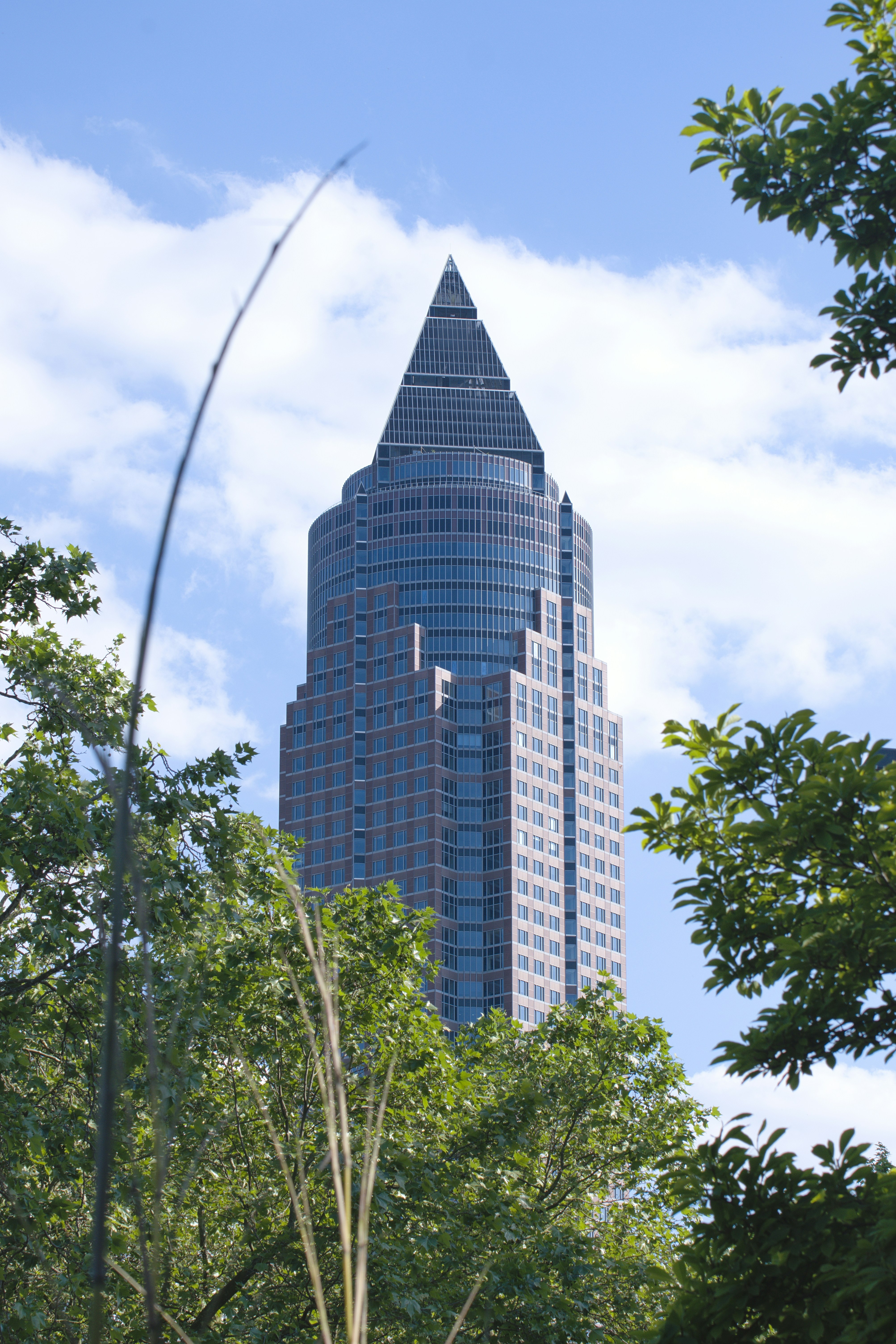 Crown of Glass: Prism Tower Rising Through Green Canopy