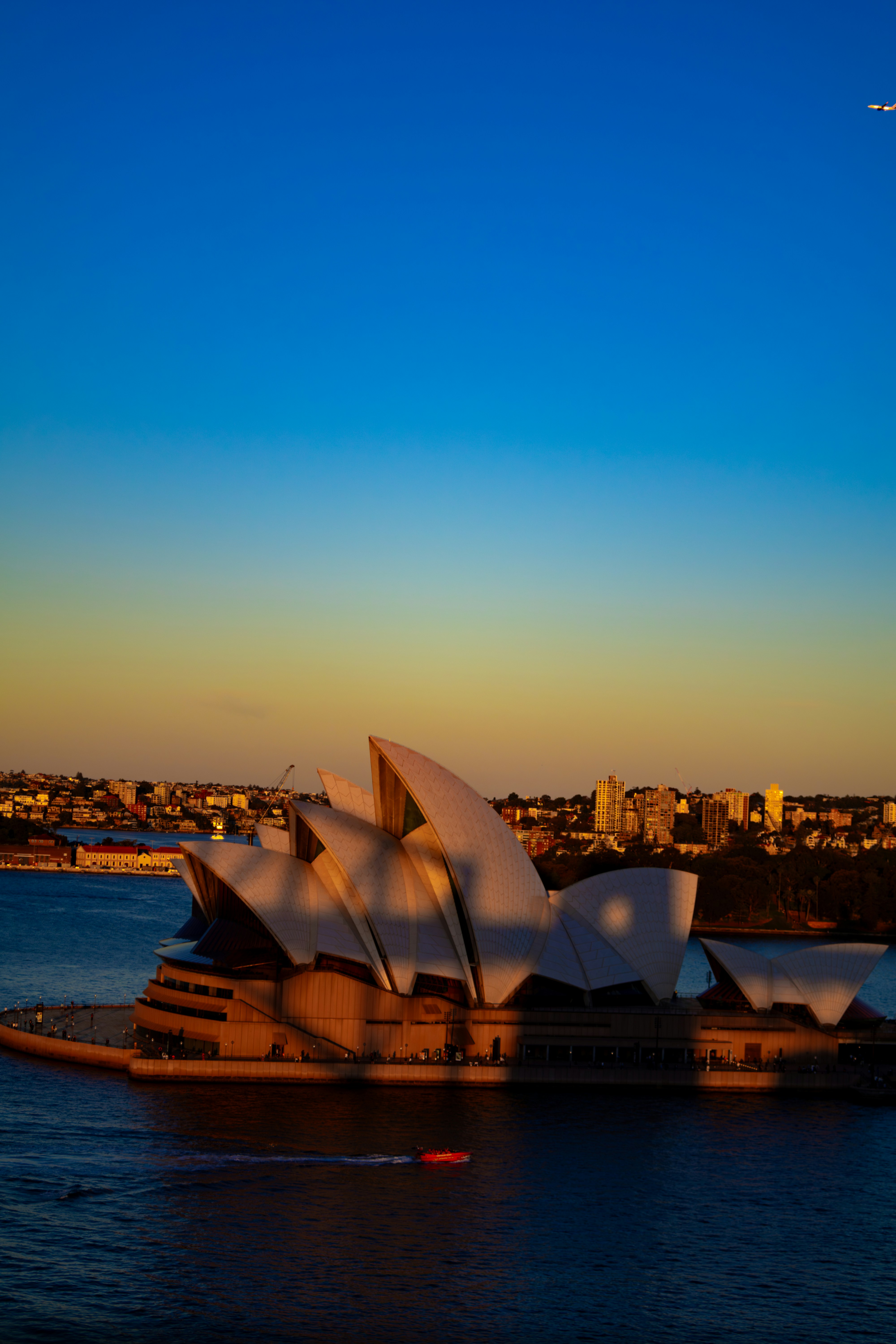 The sydney opera house is lit up at sunset photo – Free Sydney opera ...
