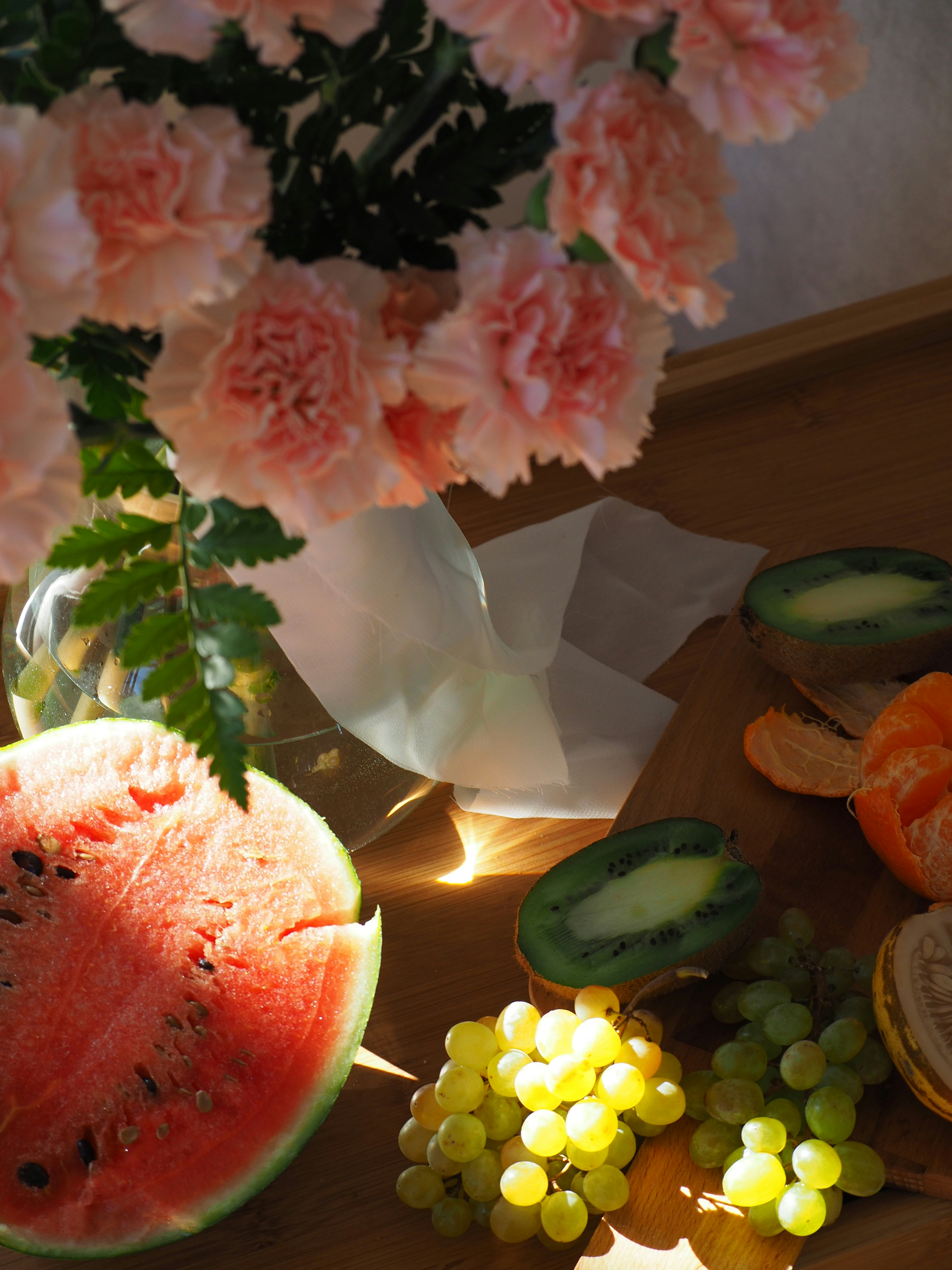 Sunlit Spread: A Fresh Still Life of Watermelon, Kiwi, and Grapes