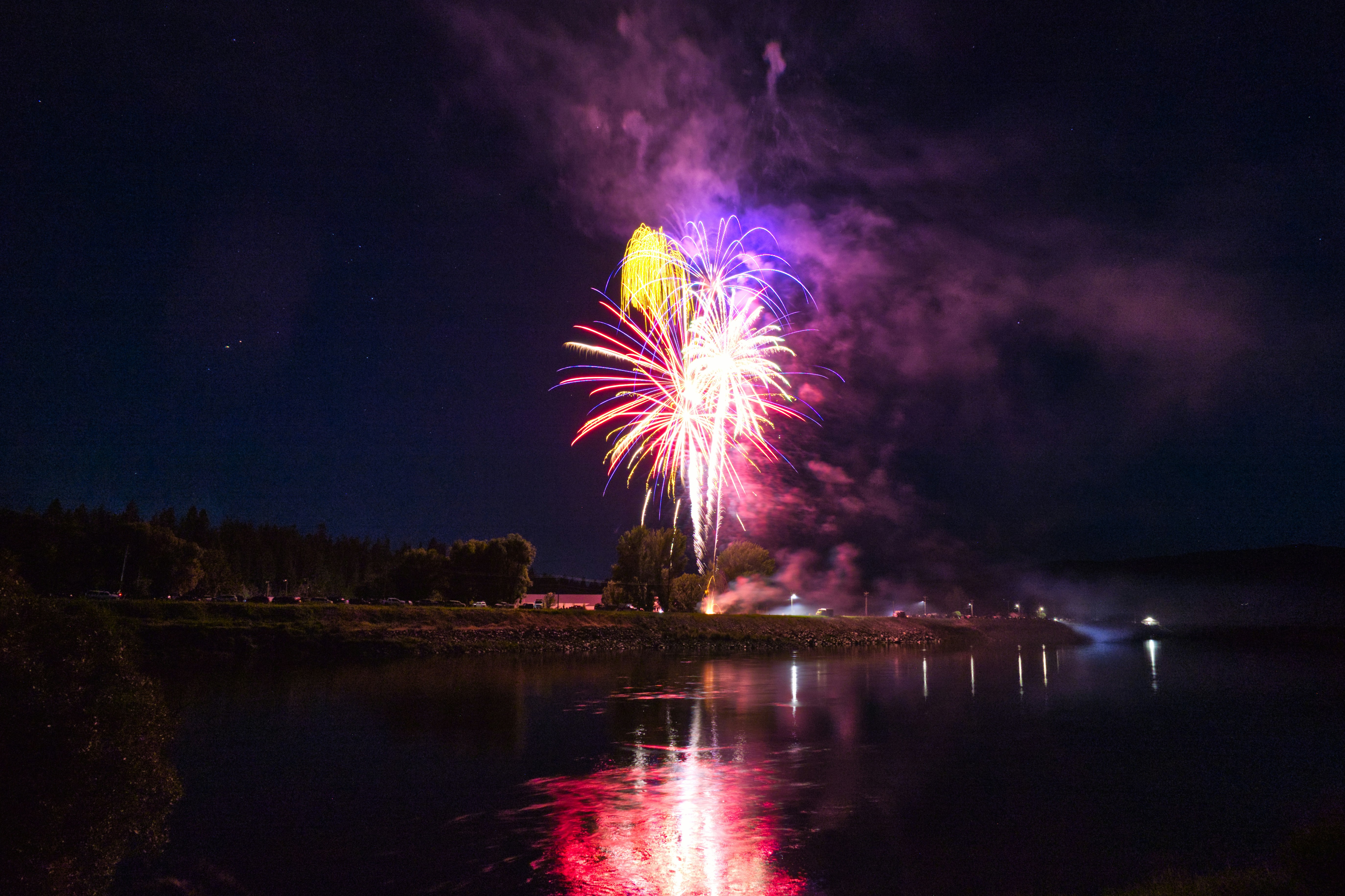 A colorful fireworks display is reflected in the water photo – Free ...